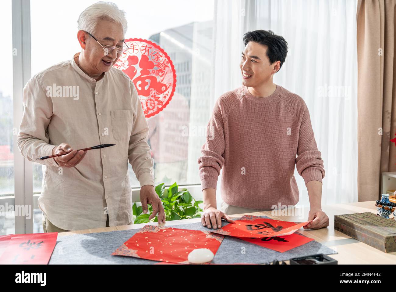Happy father and son at home to write calligraphy Stock Photo - Alamy