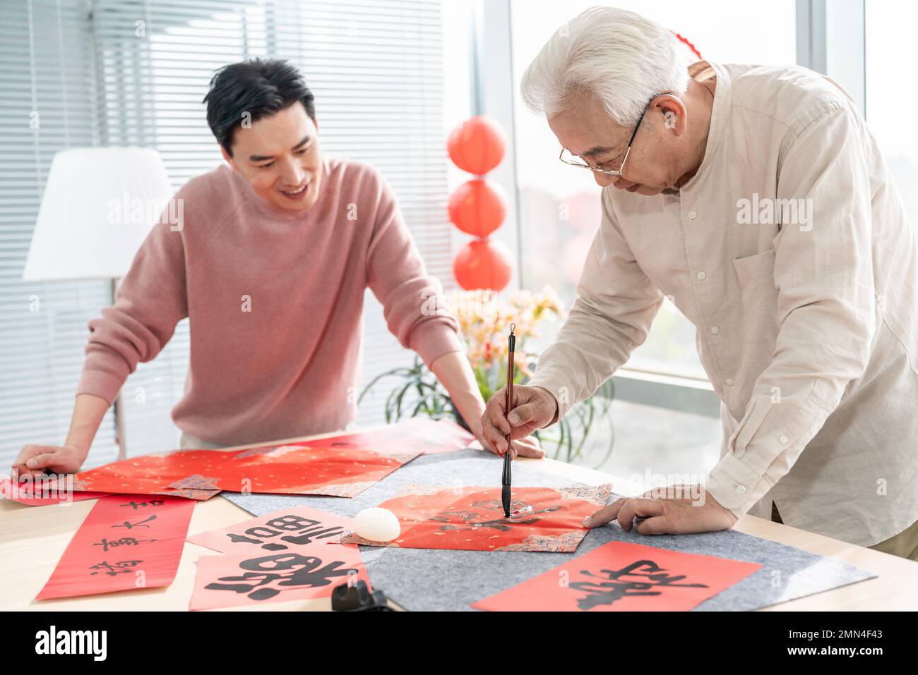 Happy father and son at home to write calligraphy Stock Photo - Alamy