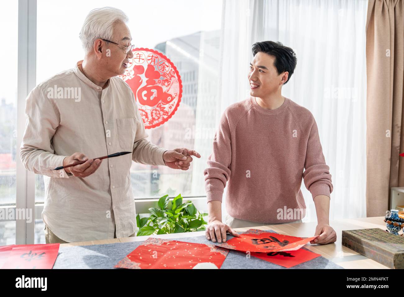 Happy father and son at home to write calligraphy Stock Photo - Alamy