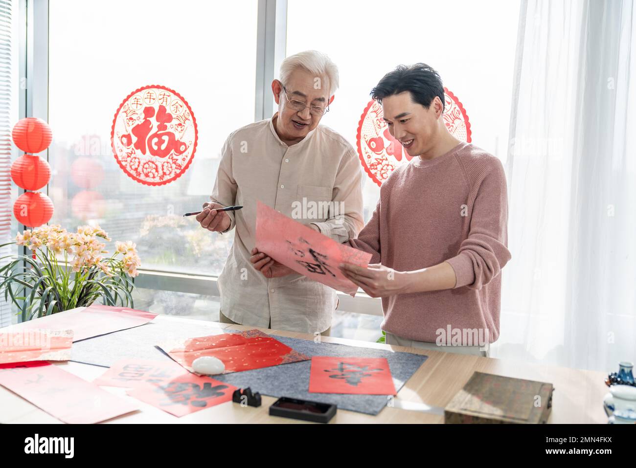 Happy father and son at home to write calligraphy Stock Photo - Alamy