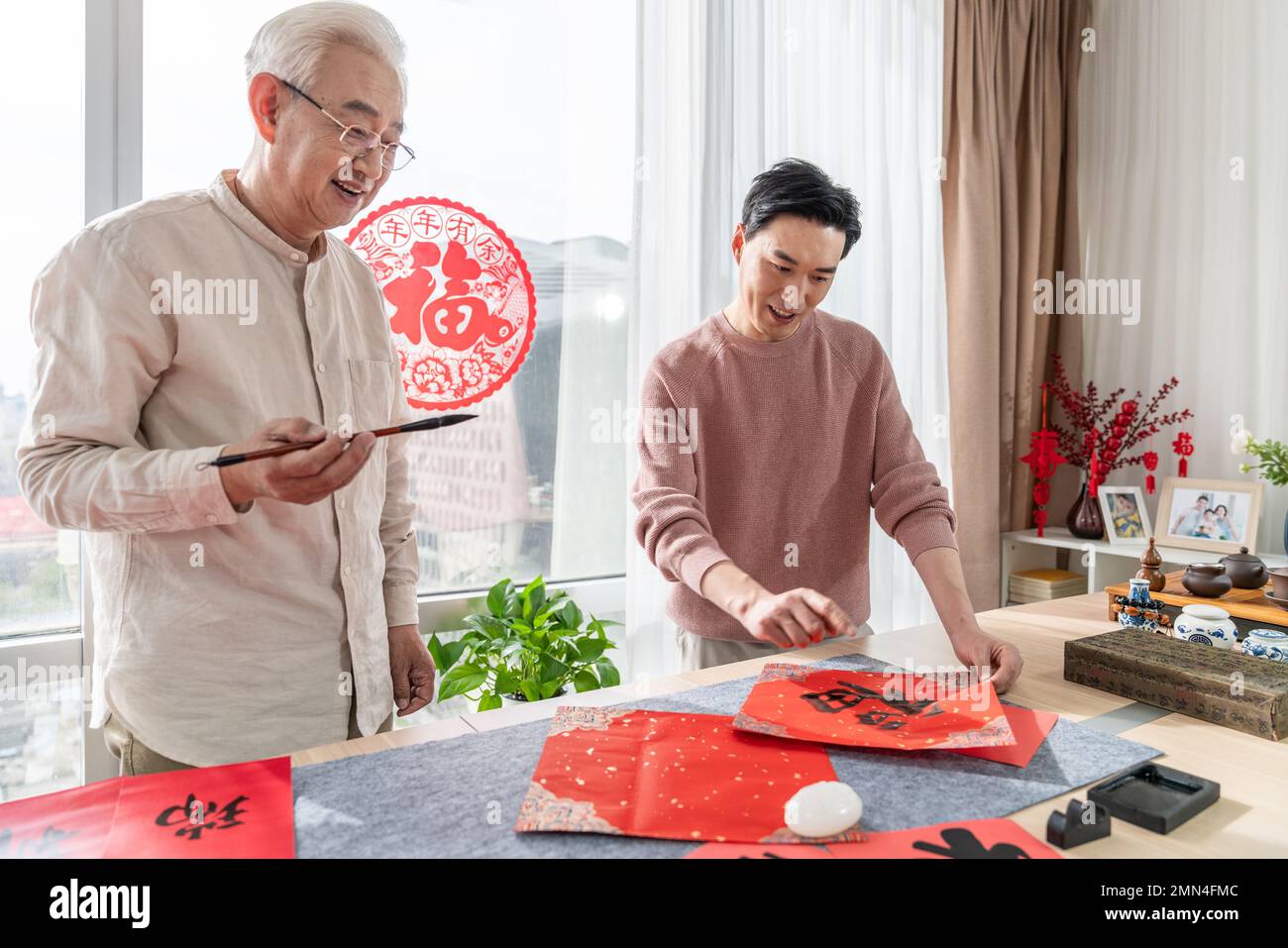 Happy father and son at home to write calligraphy Stock Photo - Alamy
