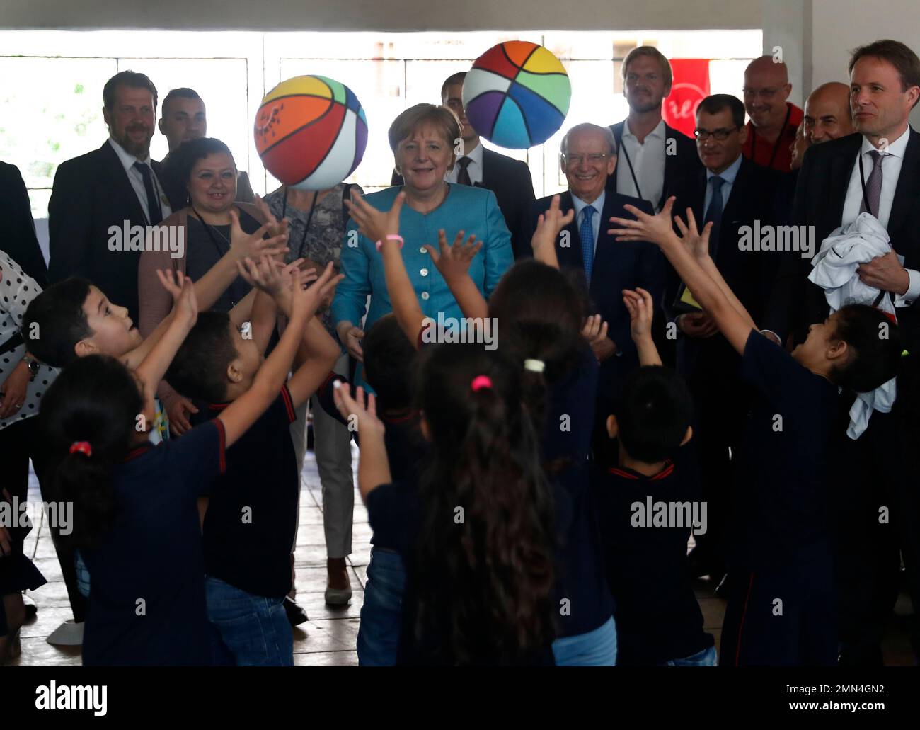 German Chancellor Angela Merkel, center, throws balls toward Lebanese ...