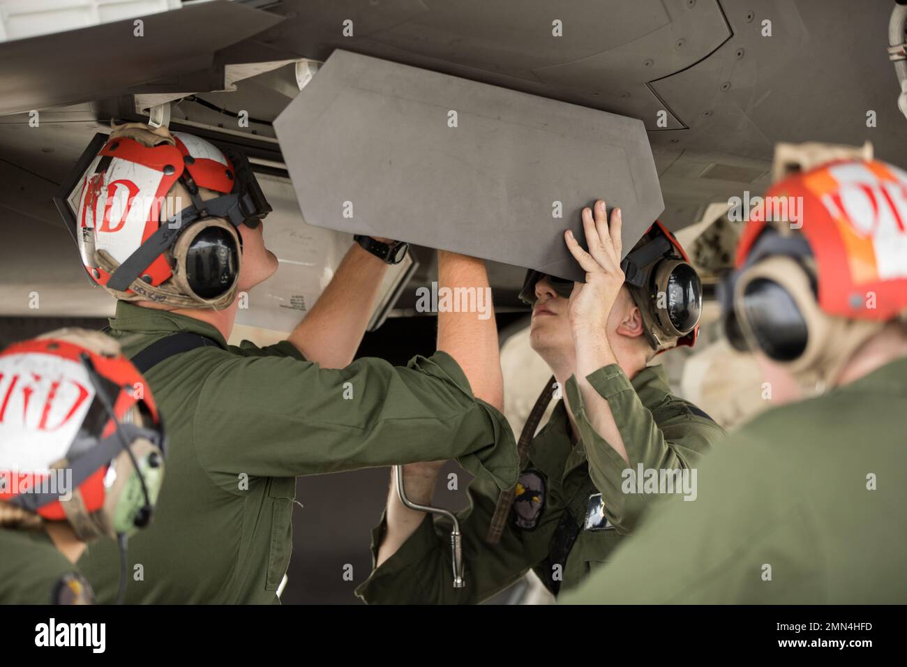 U.S. Marines with Marine Fighter Attack Squadron (VMFA) 242 load flares ...