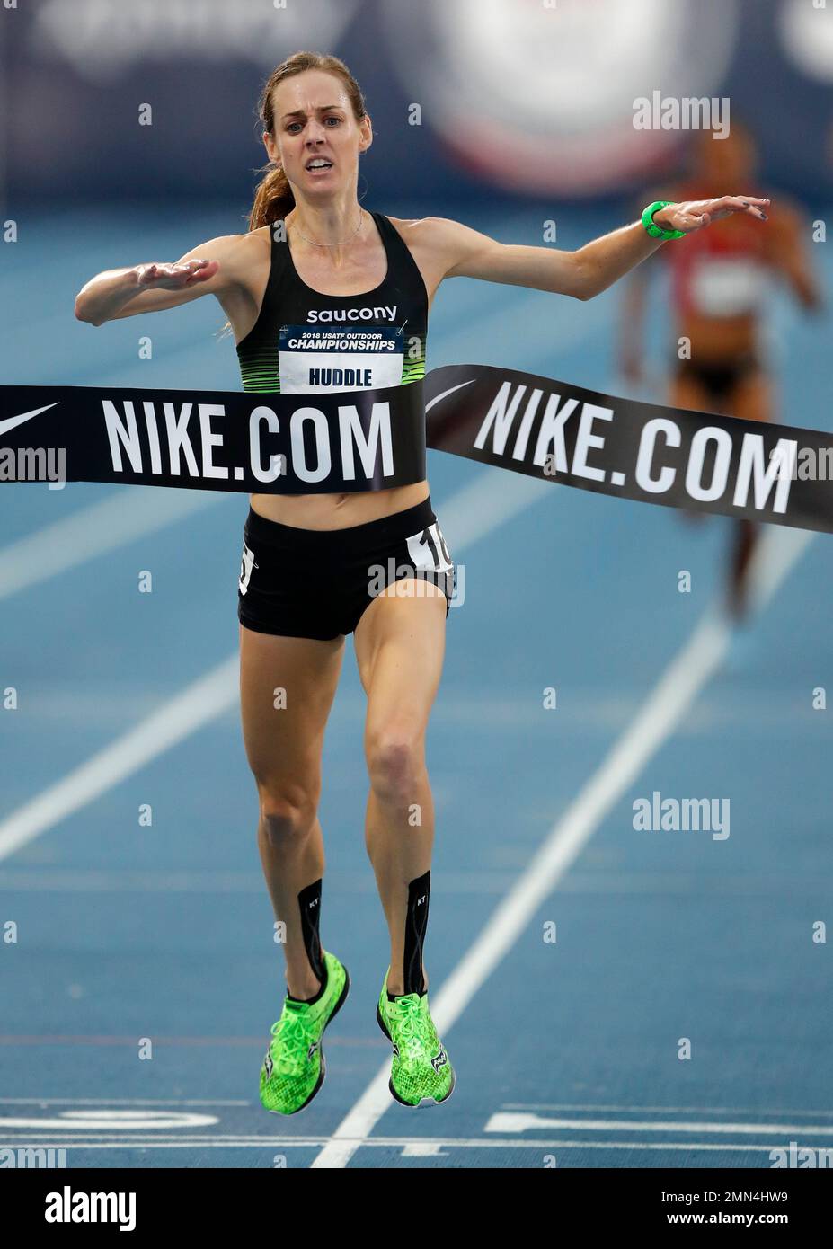 Molly Huddle crosses the finish line as she win the women's 10,000 ...