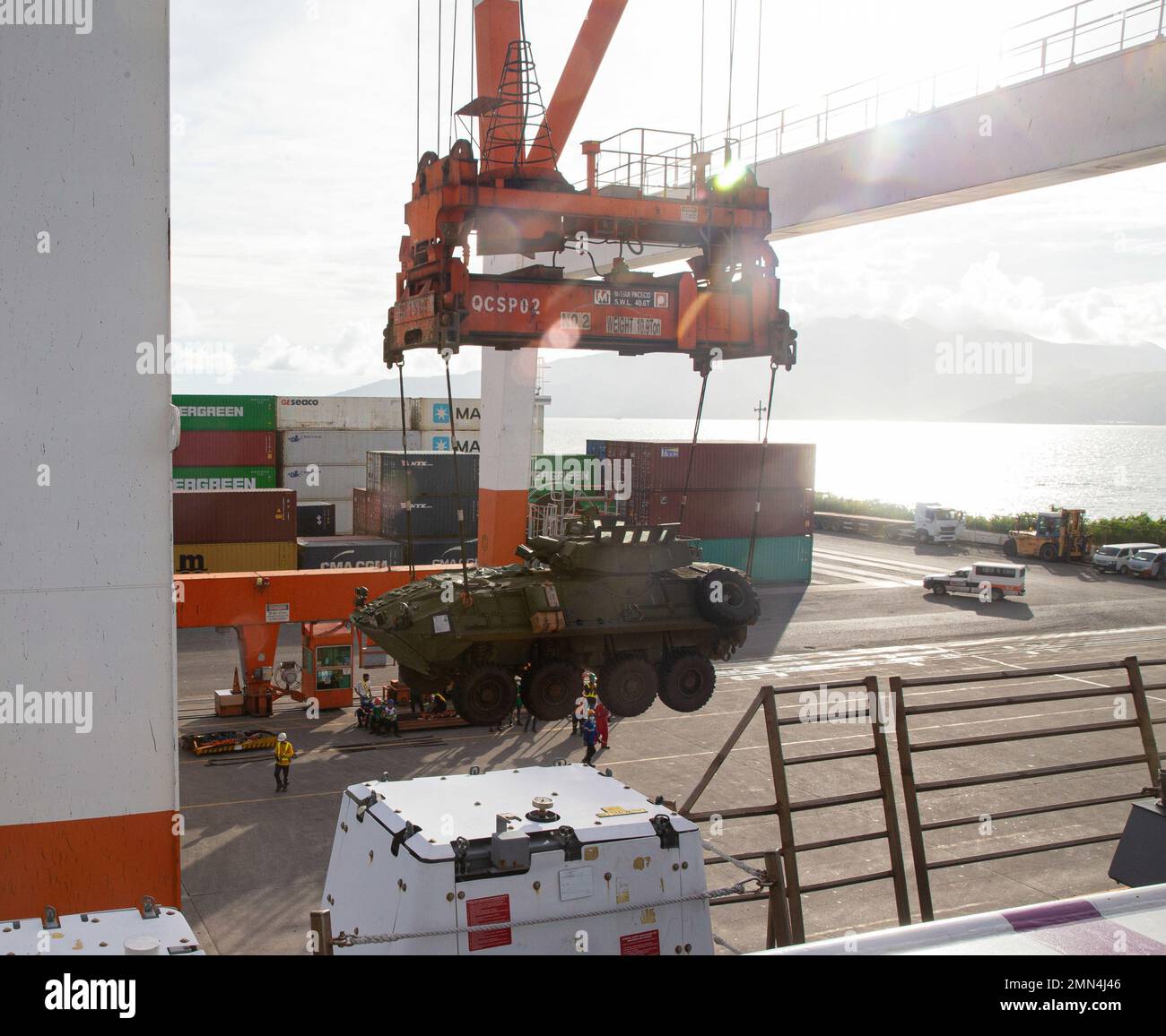 Local contractors assist with a vehicle offload in preparation for ...