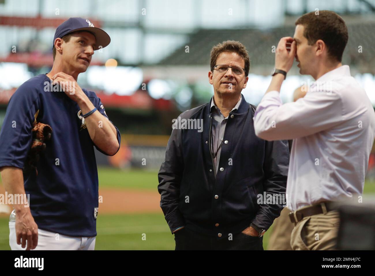 Milwaukee Brewers owner Mark Attanasio talks to manager Craig Counsell ...
