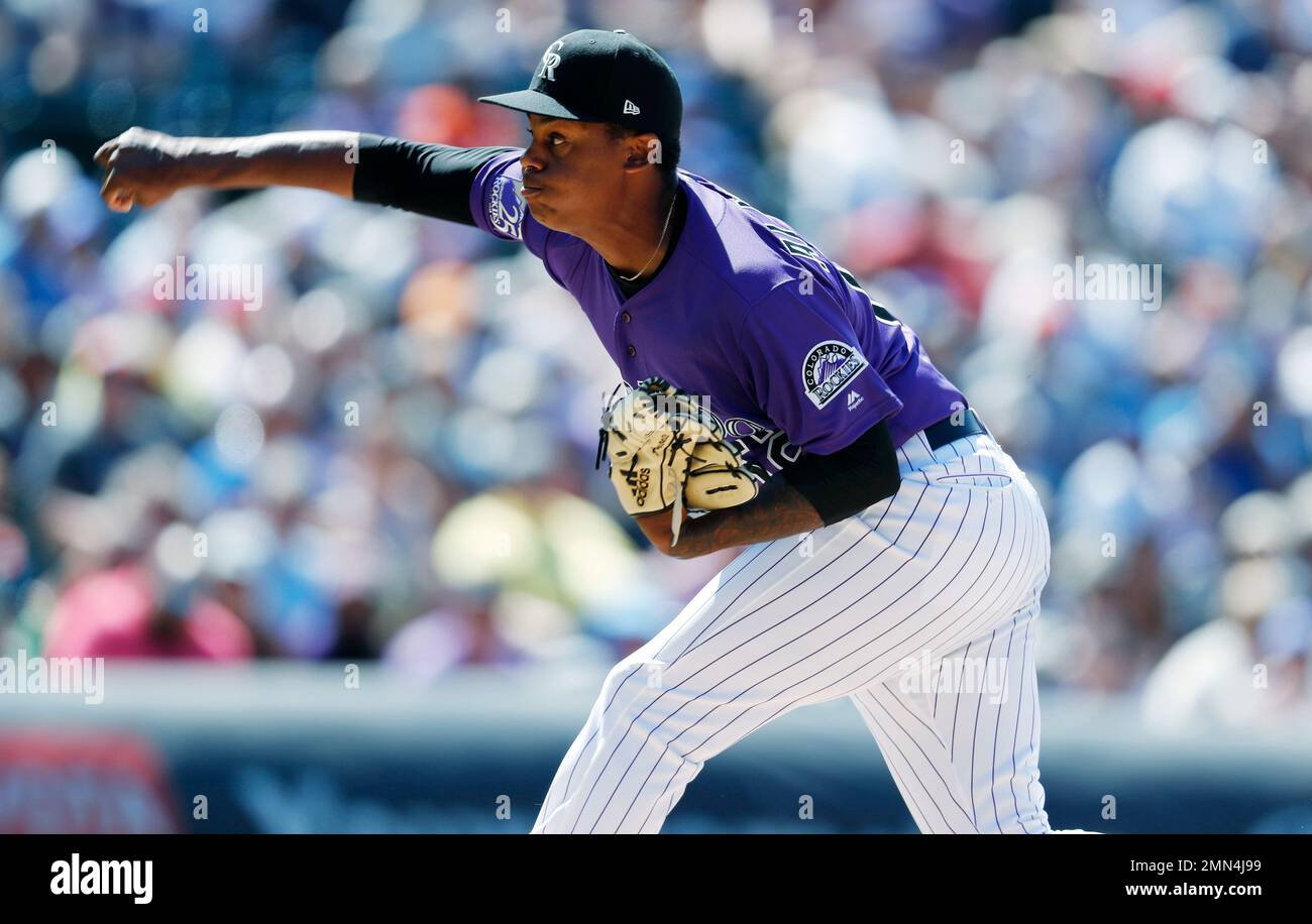 Colorado Rockies relief pitcher Yenoy Almonte throws to a New York Mets ...