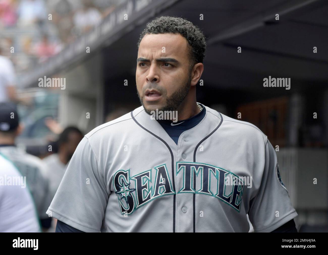 Seattle Mariners' Nelson Cruz looks on from the dugout before a ...