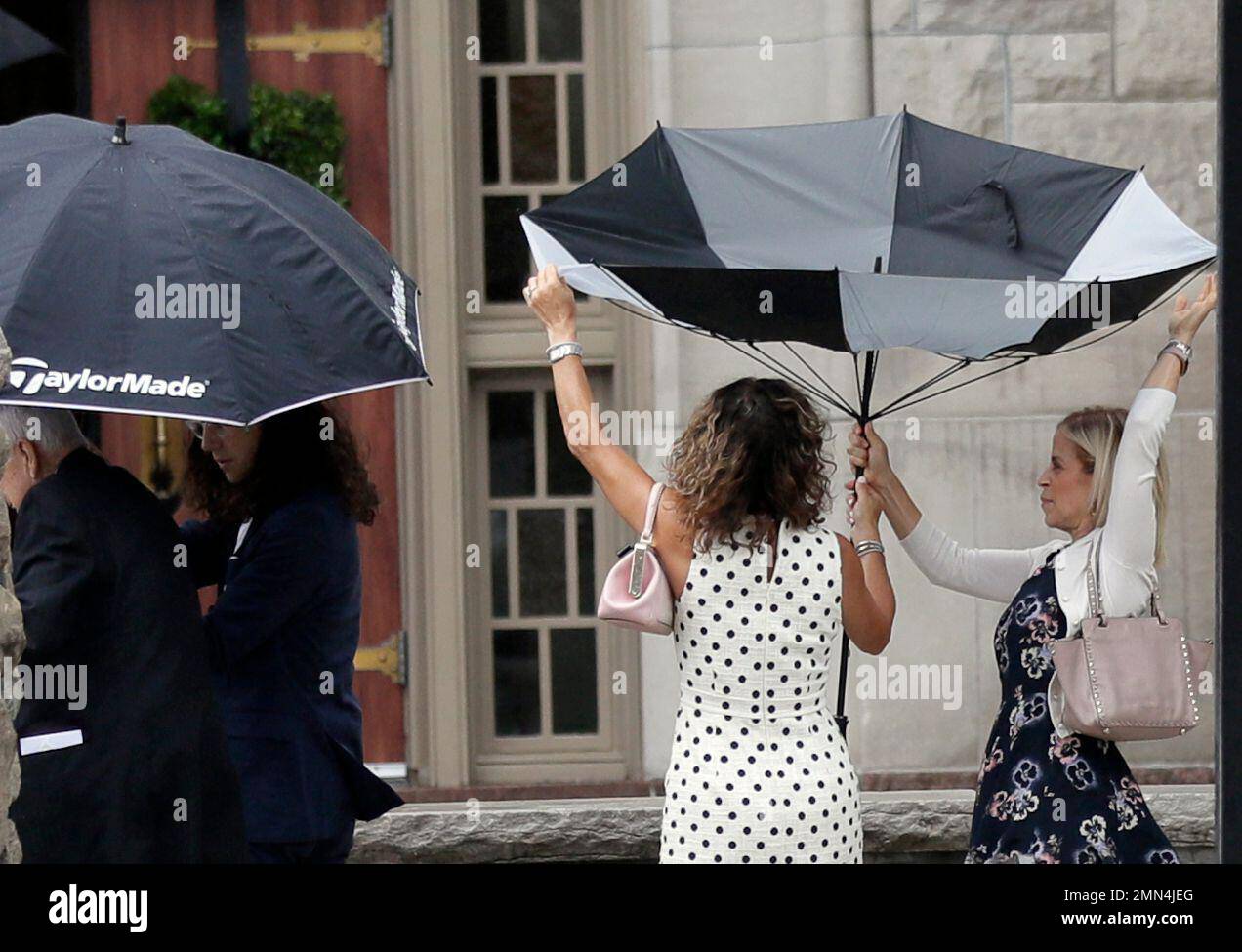 Mourners battle wind and rain while entering Our Lady of Perpetual Help ...