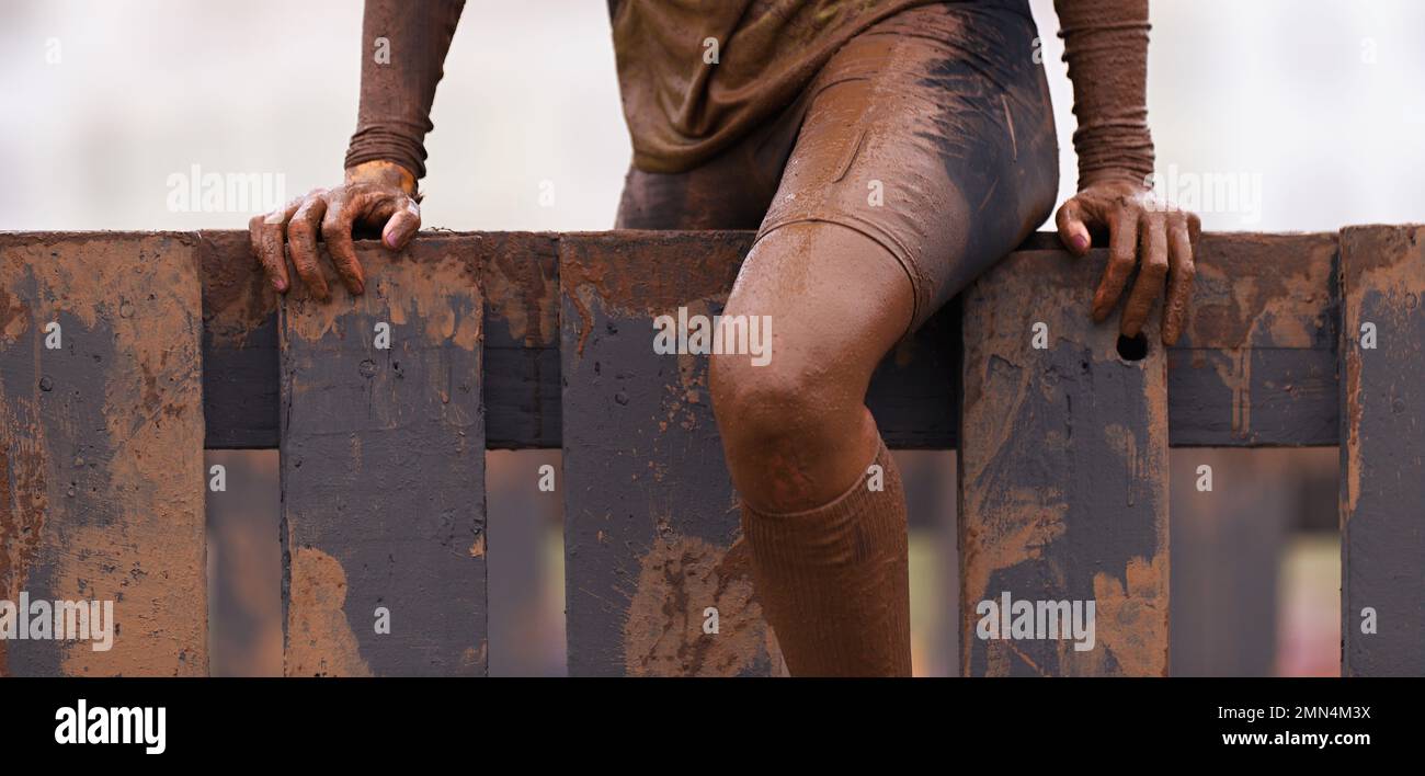 Mud race runners running over obstacles extreme sport Stock Photo - Alamy