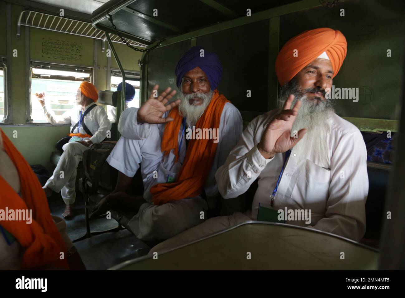 Indian Sikh wave as they arrive at Lahore railway station in Pakistan ...