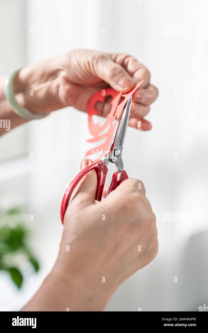 Elderly women in paper cutting Stock Photo - Alamy