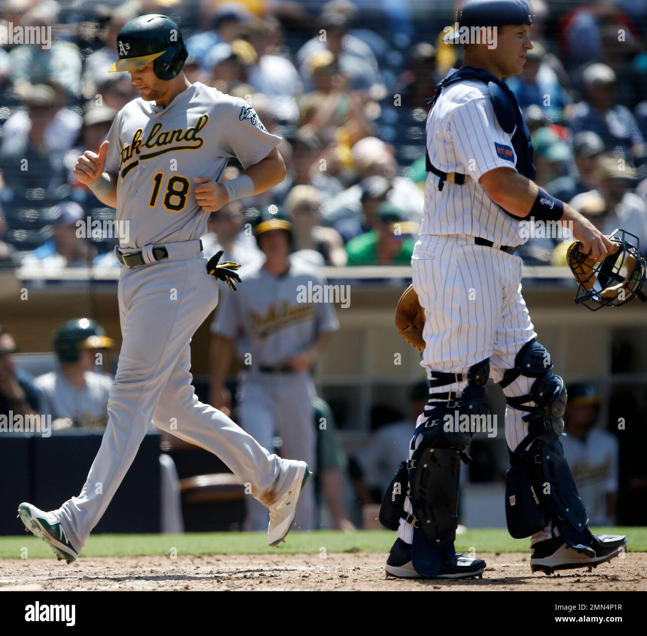Oakland Athletics' Chad Pinder, left, scores on a single by Matt Olson ...