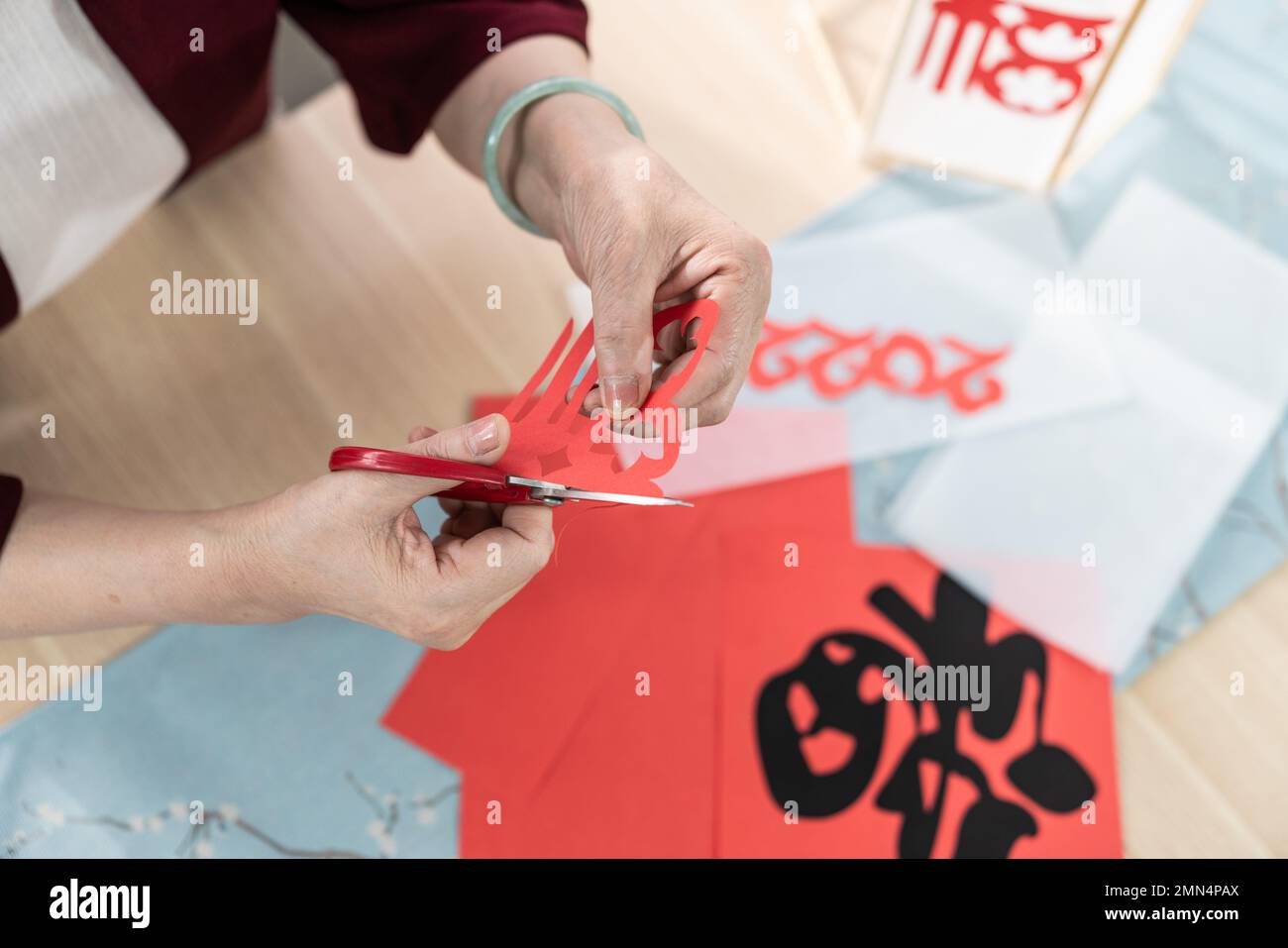 Elderly women in paper cutting Stock Photo - Alamy