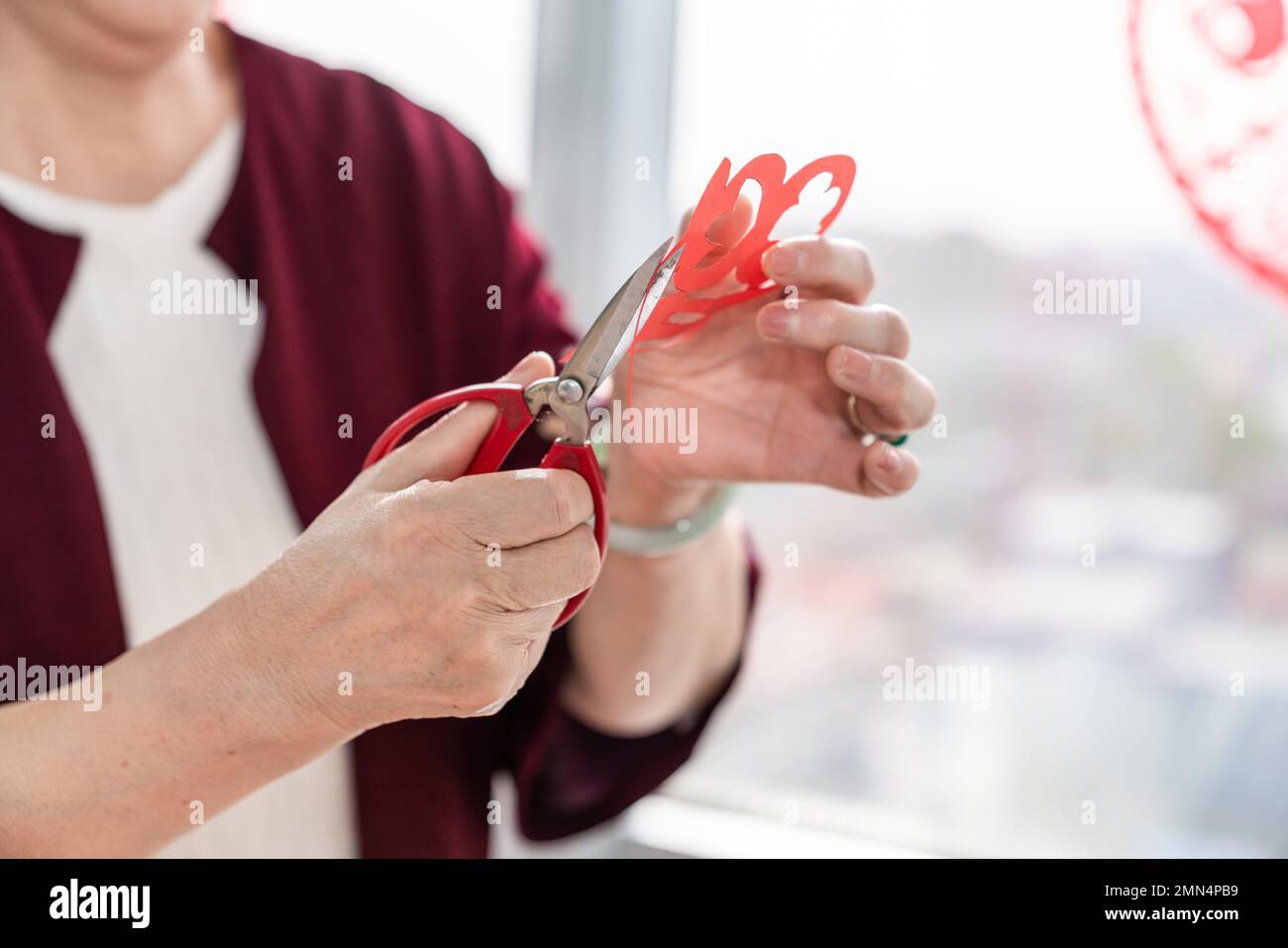 Elderly women in paper cutting Stock Photo - Alamy