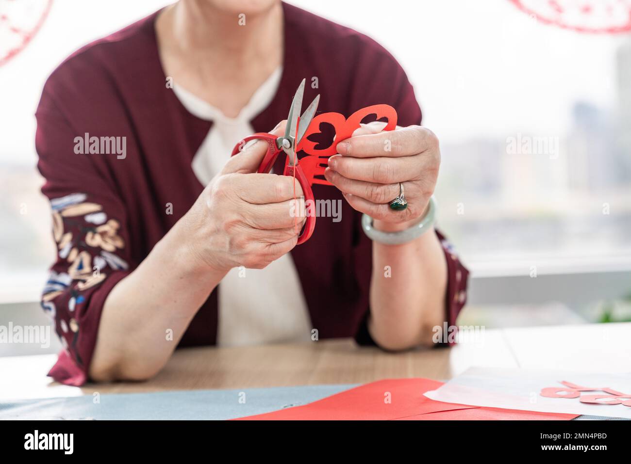 Elderly women in paper cutting Stock Photo - Alamy