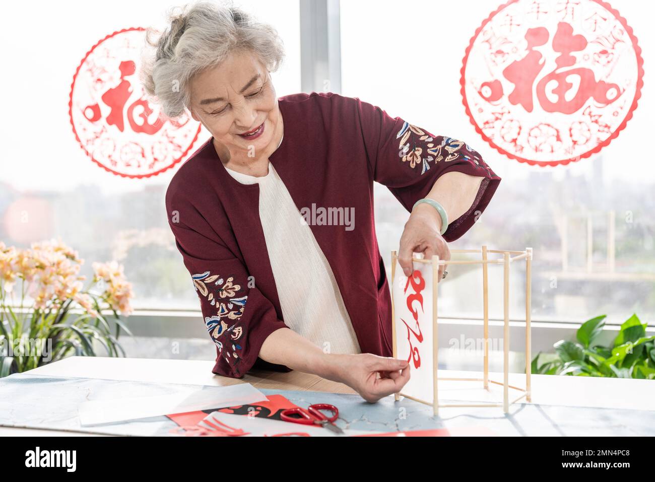 Elderly women in paper cutting Stock Photo - Alamy