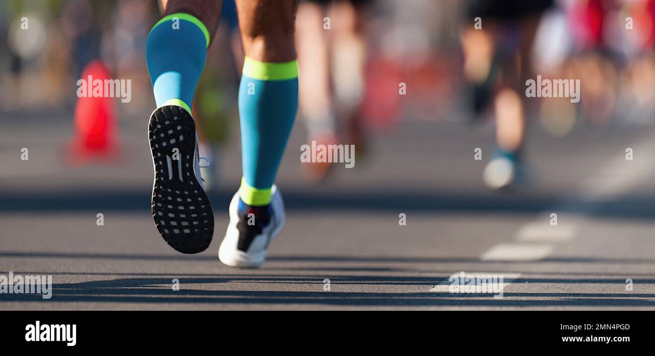 Marathon running race, people feet on city road Stock Photo - Alamy