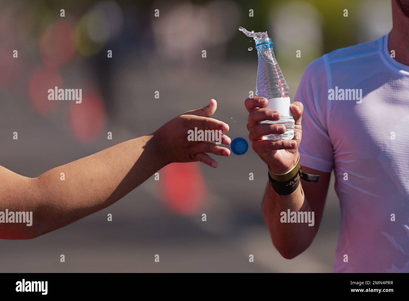 The hand of the runner grabbing the water Stock Photo - Alamy