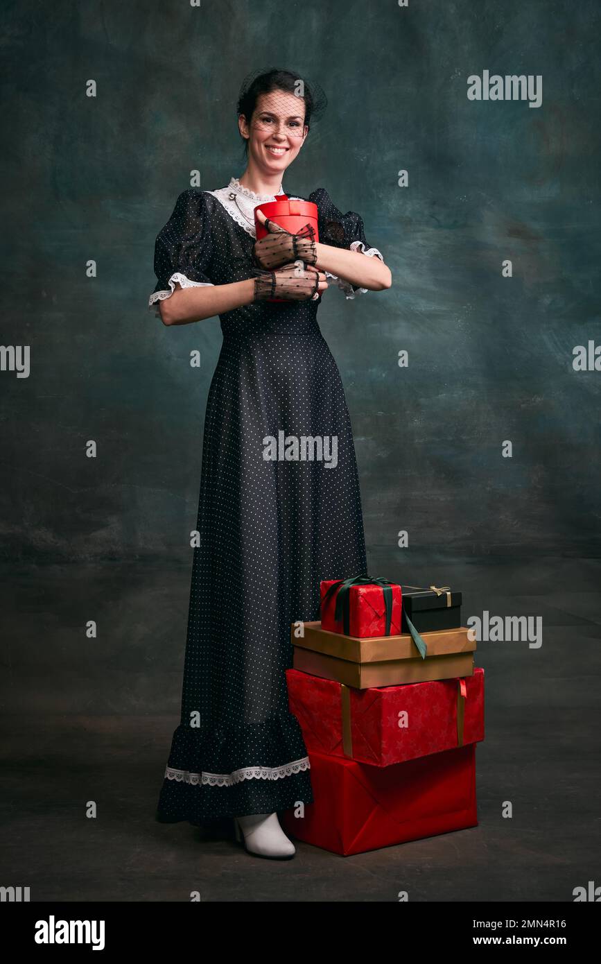 With present boxes. Young beautiful woman in image of Anna Karenina in ...