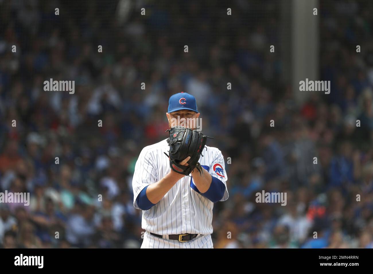 Chicago Cubs starting pitcher Jon Lester checks the runner at first ...