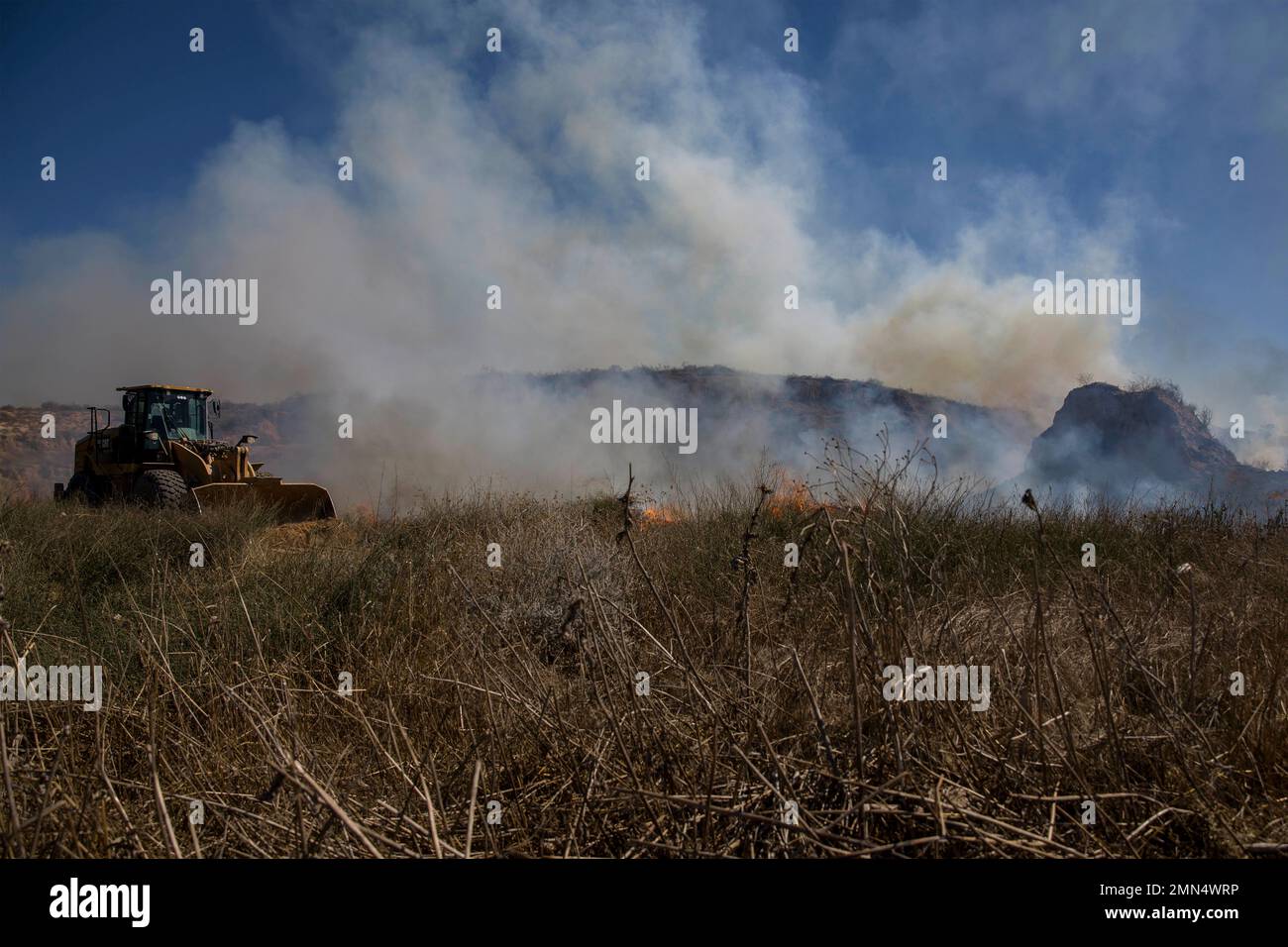 An Israeli tractor extinguishes a fire started by a kite with attached ...