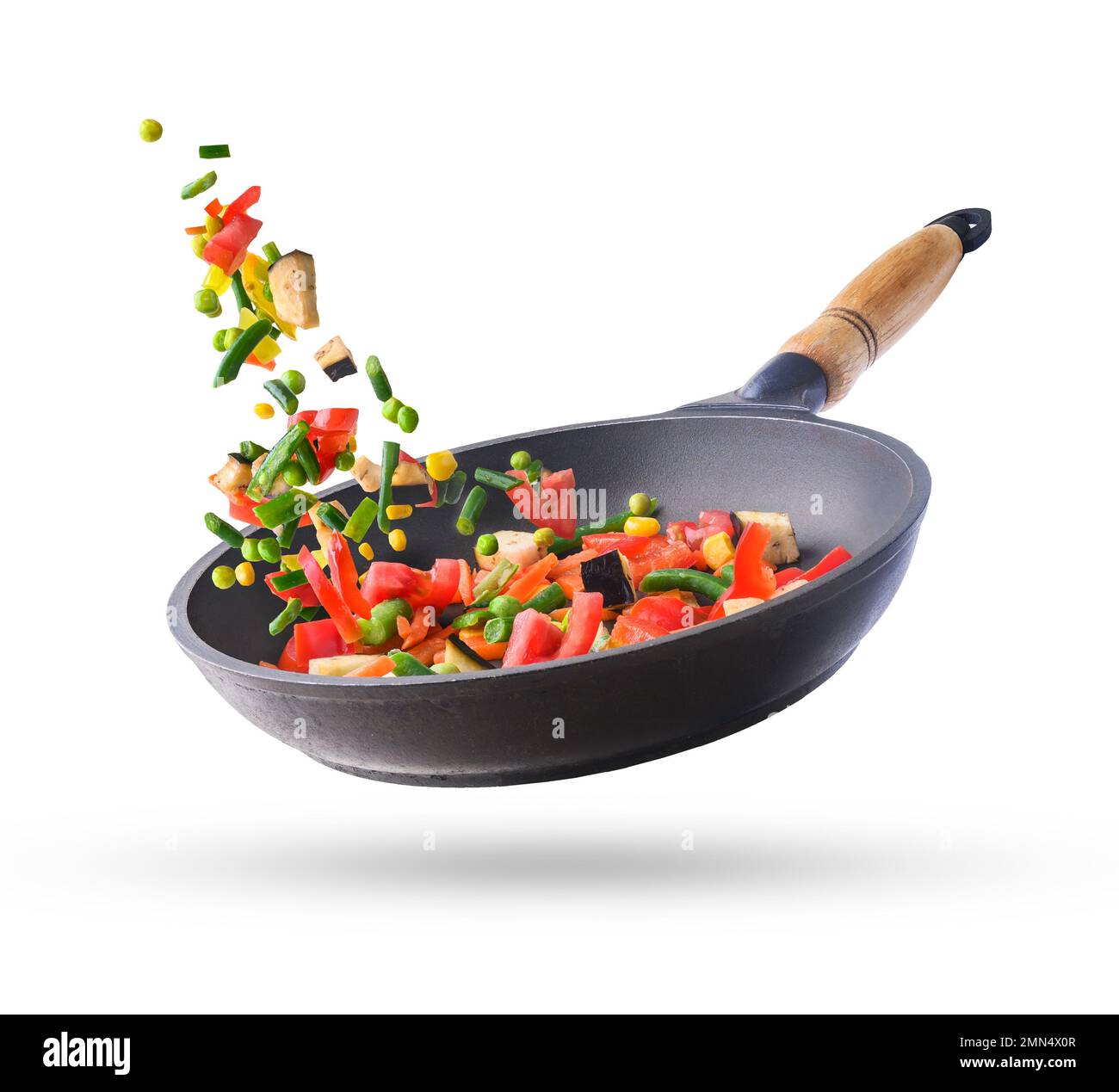 Fresh chopped vegetables mix flying in a pan, isolated on white ...