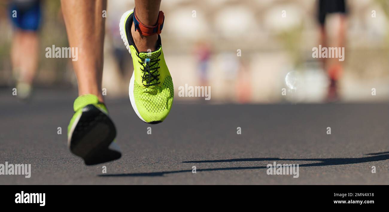 Marathon running race, people feet on city road Stock Photo - Alamy