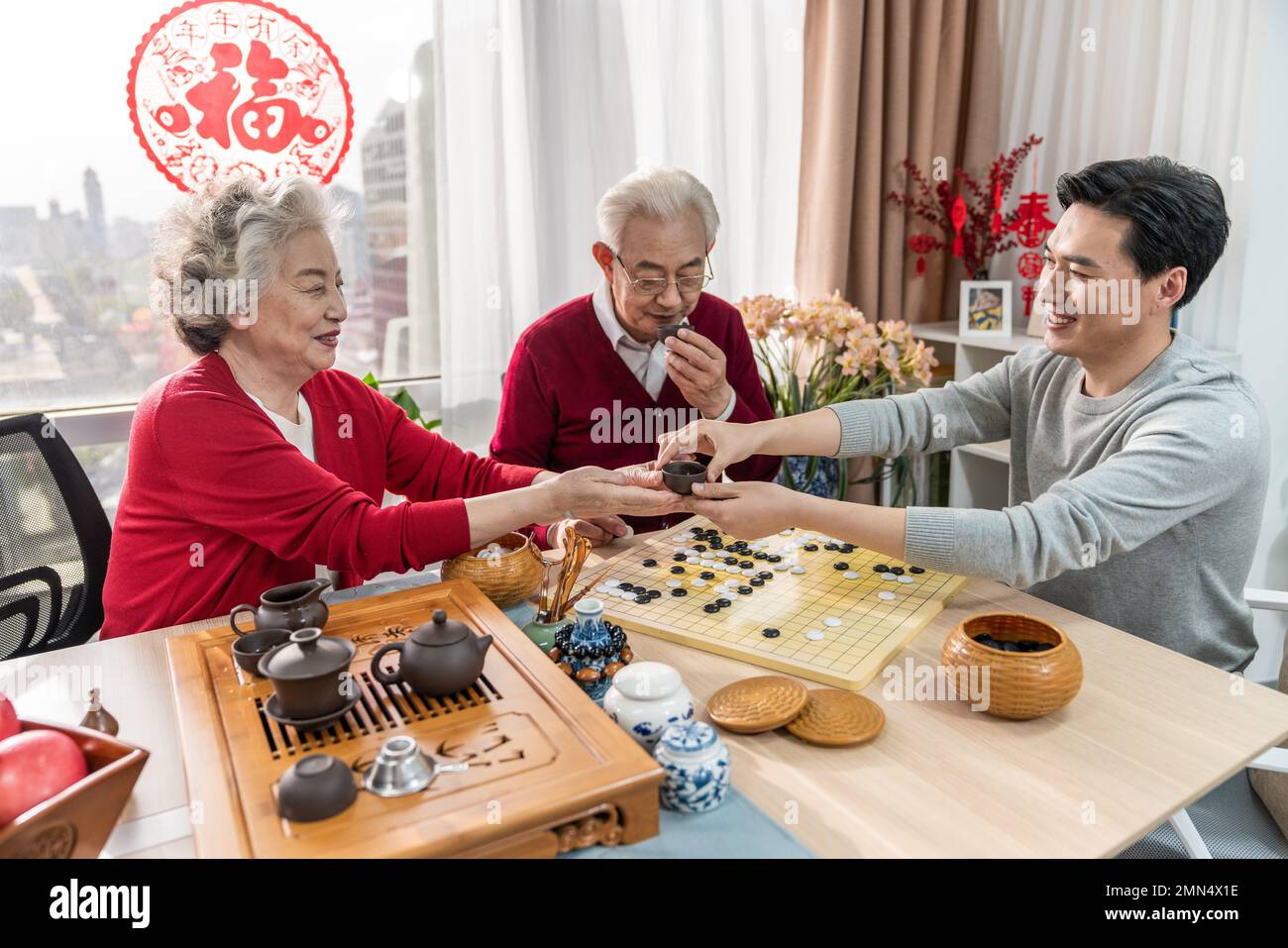 Happy family go over a cup of tea Stock Photo - Alamy