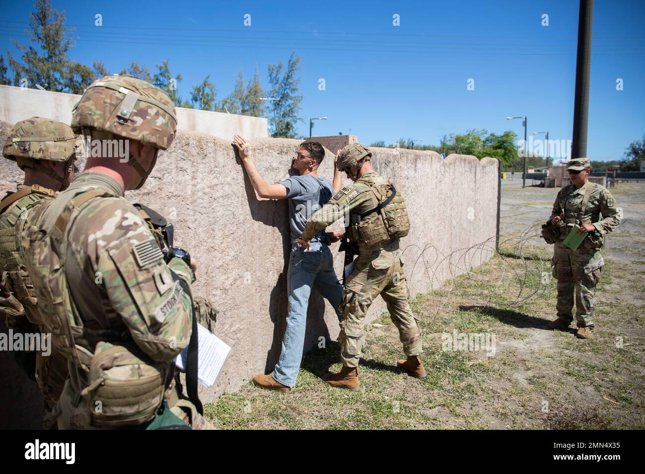 A U.S. Soldier with the 58th Military Police Company searches a ...