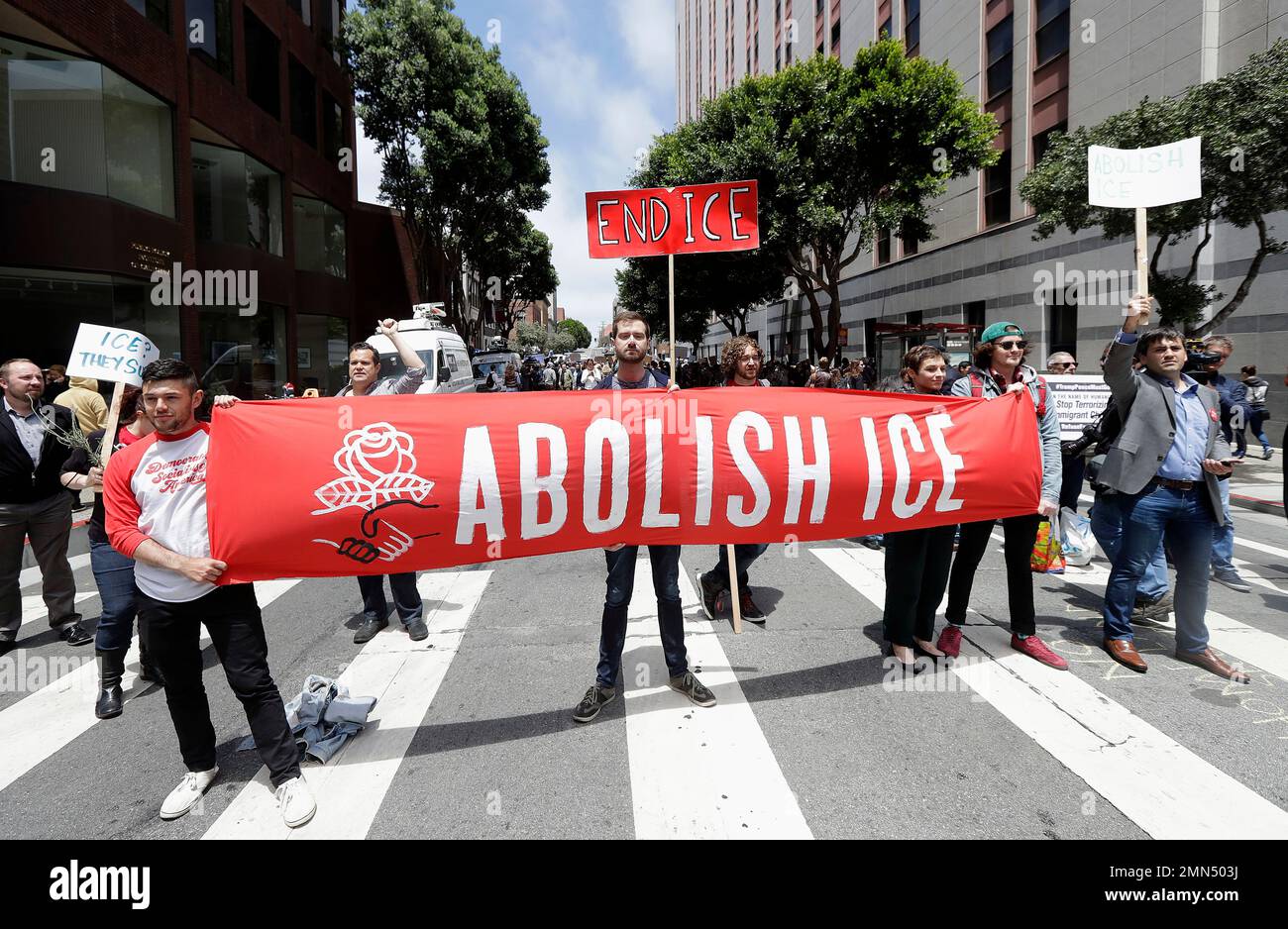 Protesters hold up signs outside of the Immigration and Customs ...