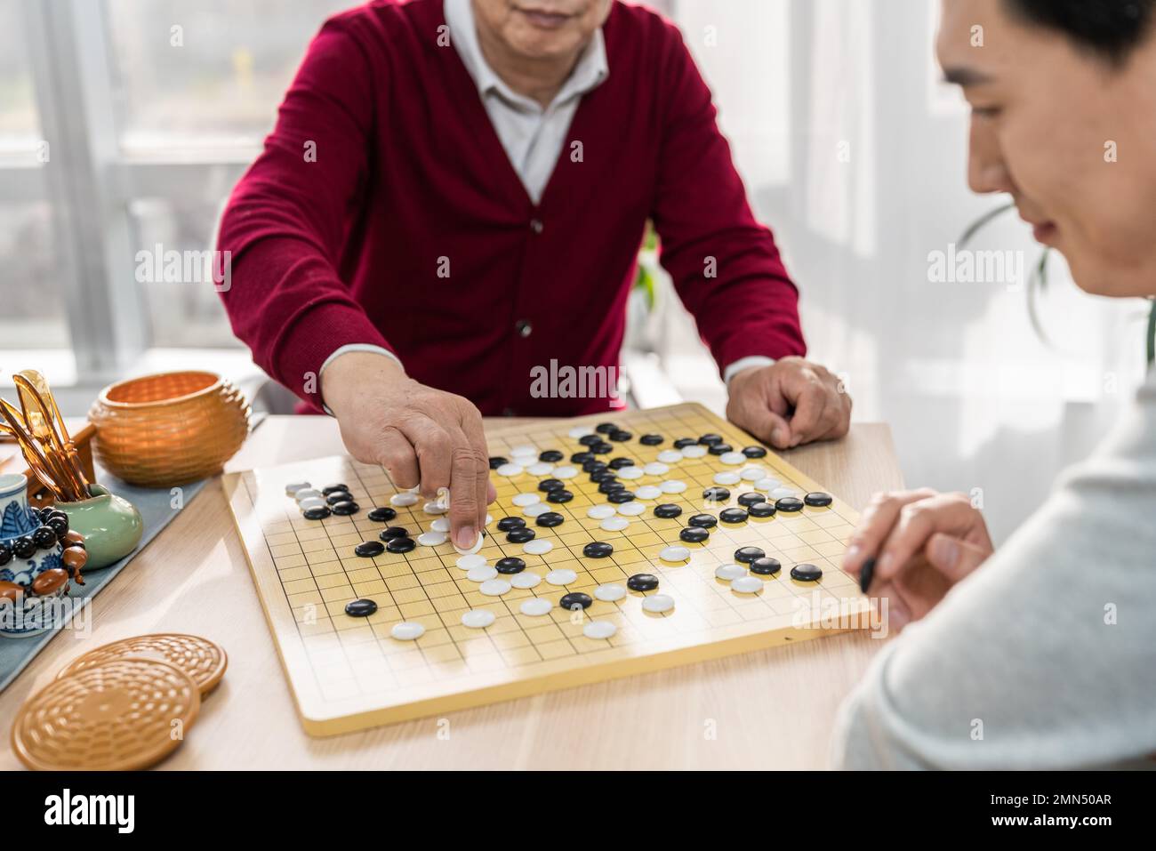 Happy father and son play weiqi Stock Photo - Alamy
