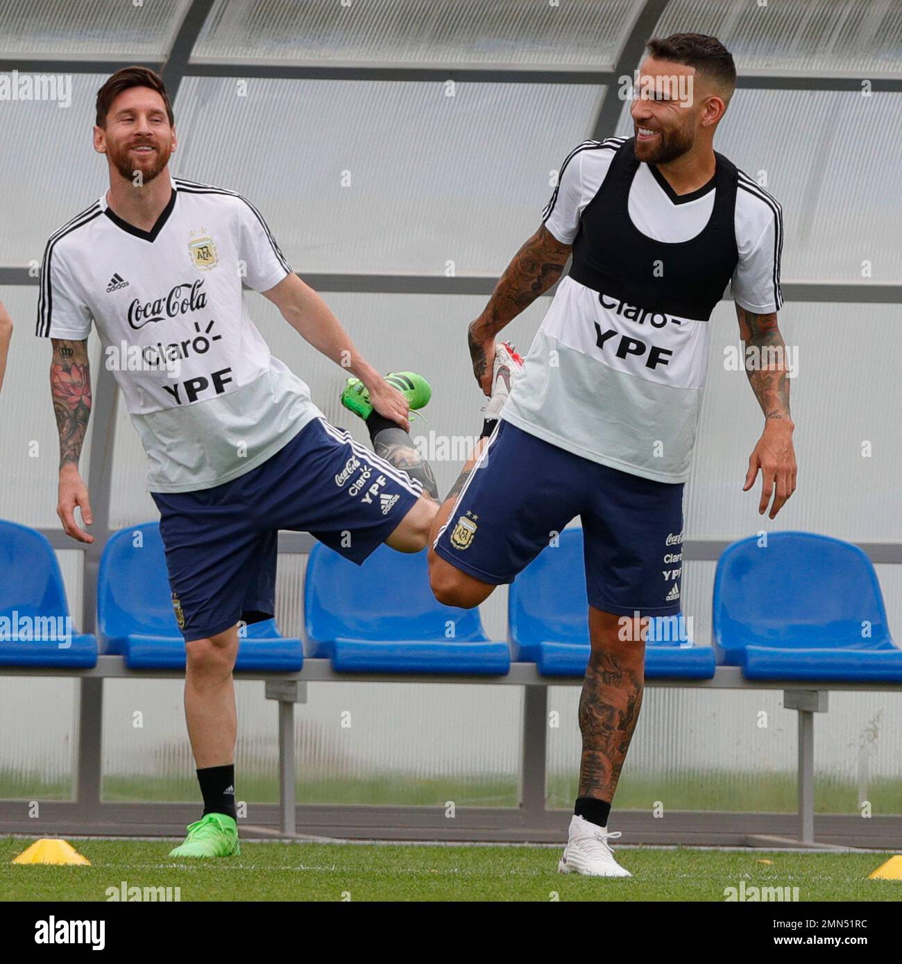 Lionel Messi, left, and Nicolas Otamendi stretch during a training ...