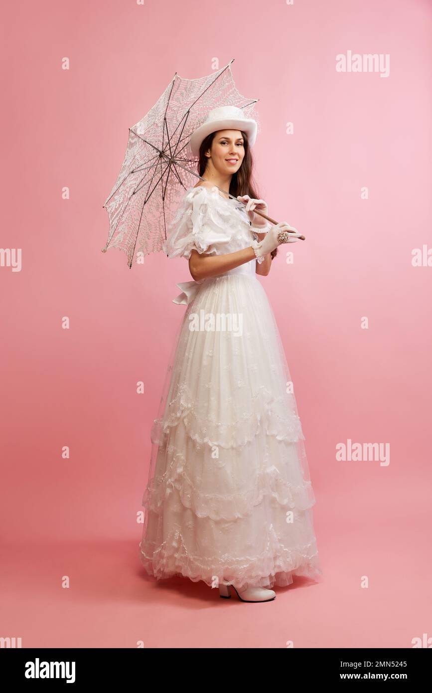 Noble woman. Portrait of beautiful lady in white vintage dress posing ...