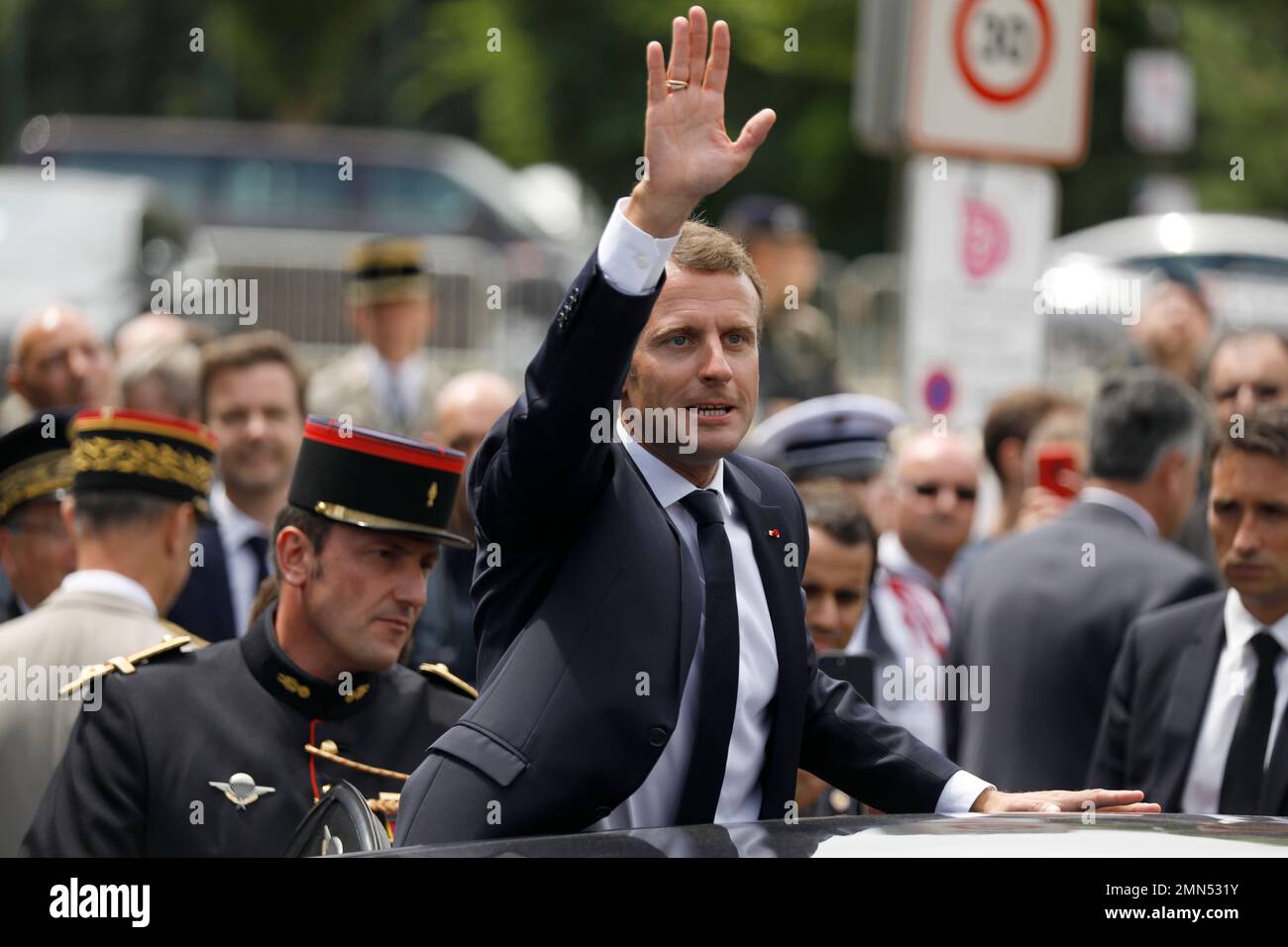French President Emmanuel Macron waves to the crowd as he leaves after ...