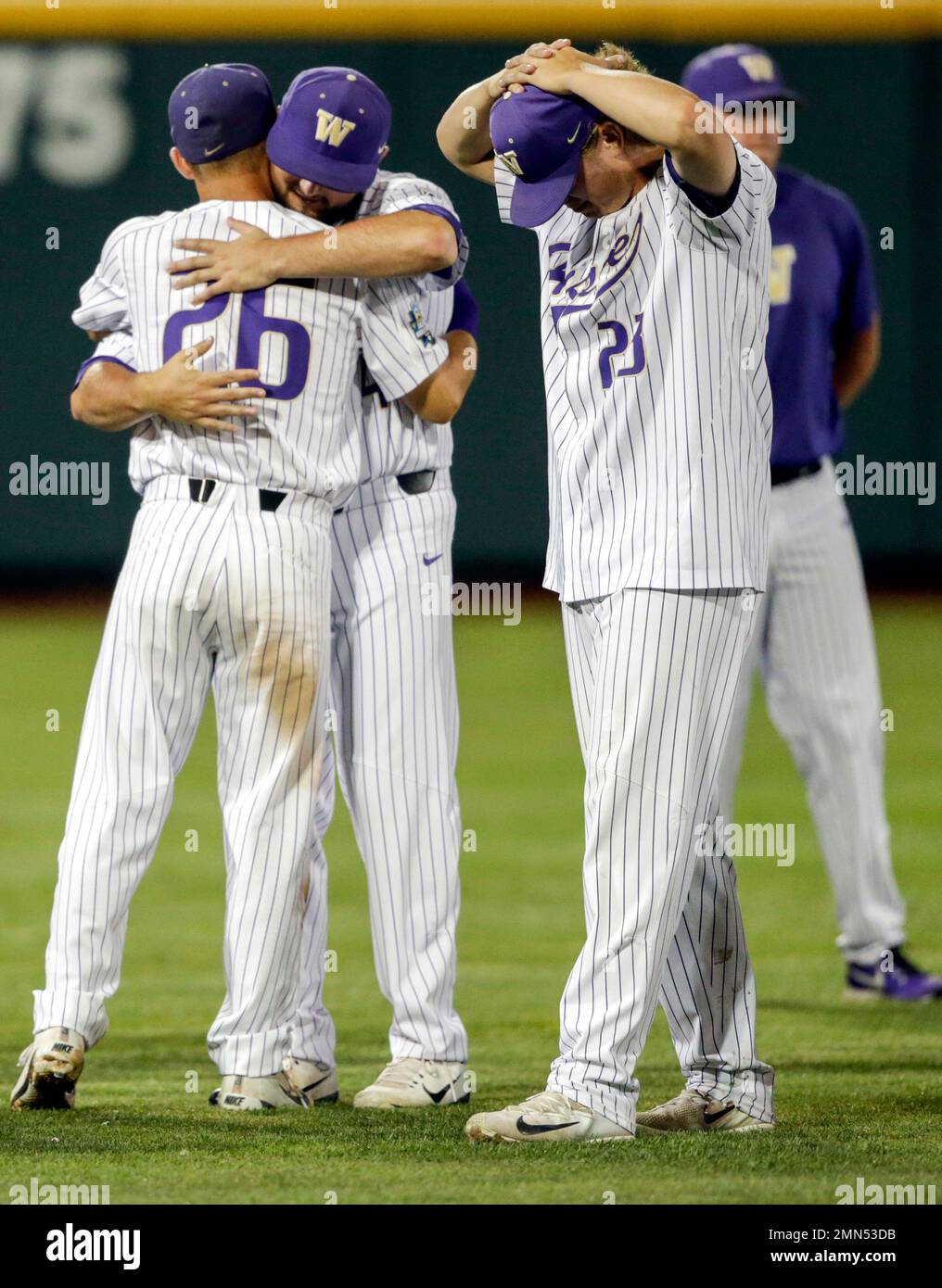 Washington's Levi Jordan (26) and Joe DeMers hug as Dylan Lamb (23 ...