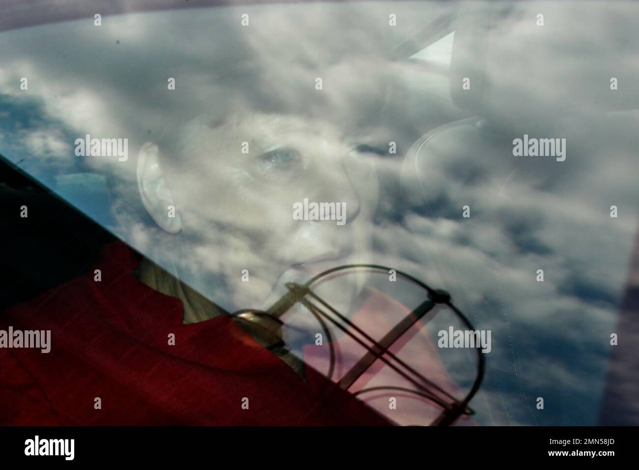 German Chancellor Angela Merkel sits in a car as she arrives for a ...