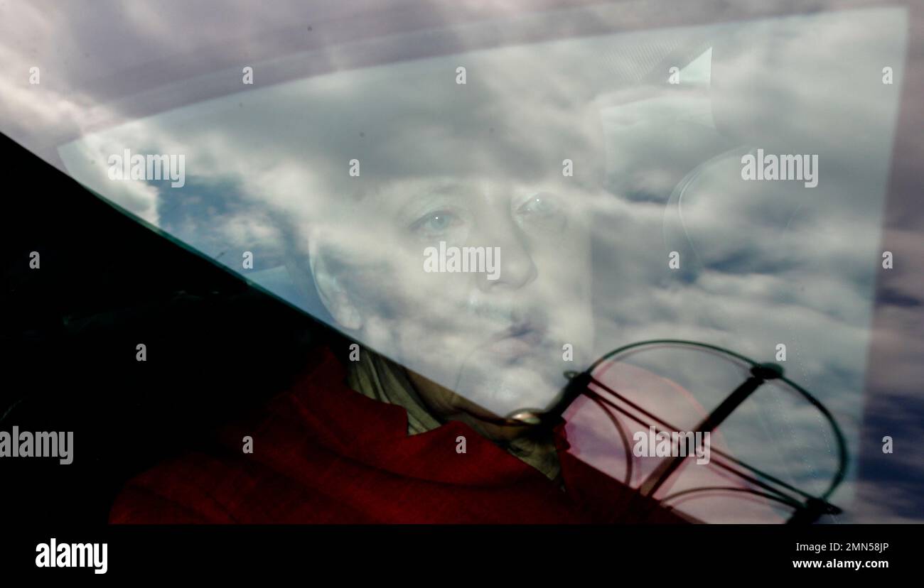 German Chancellor Angela Merkel sits in a car as she arrives for a ...