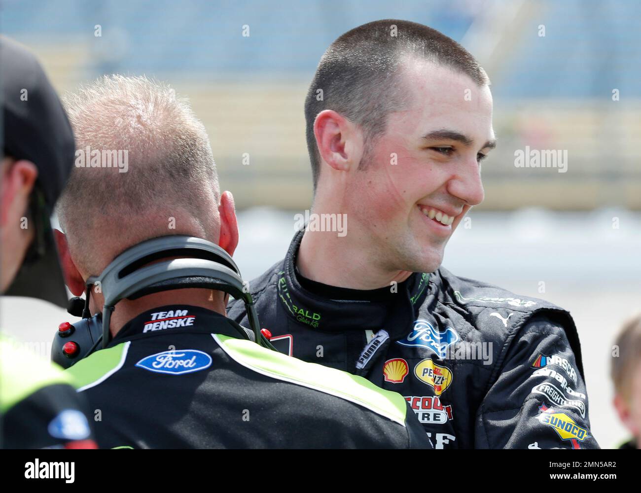 Austin Cindric celebrates with crew members after winning the pole ...