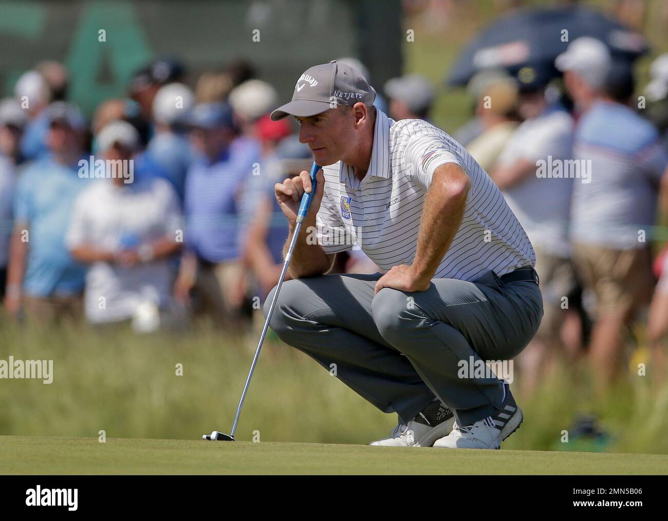 Jim Furyk lines up a putt on the seventh green during the final round ...
