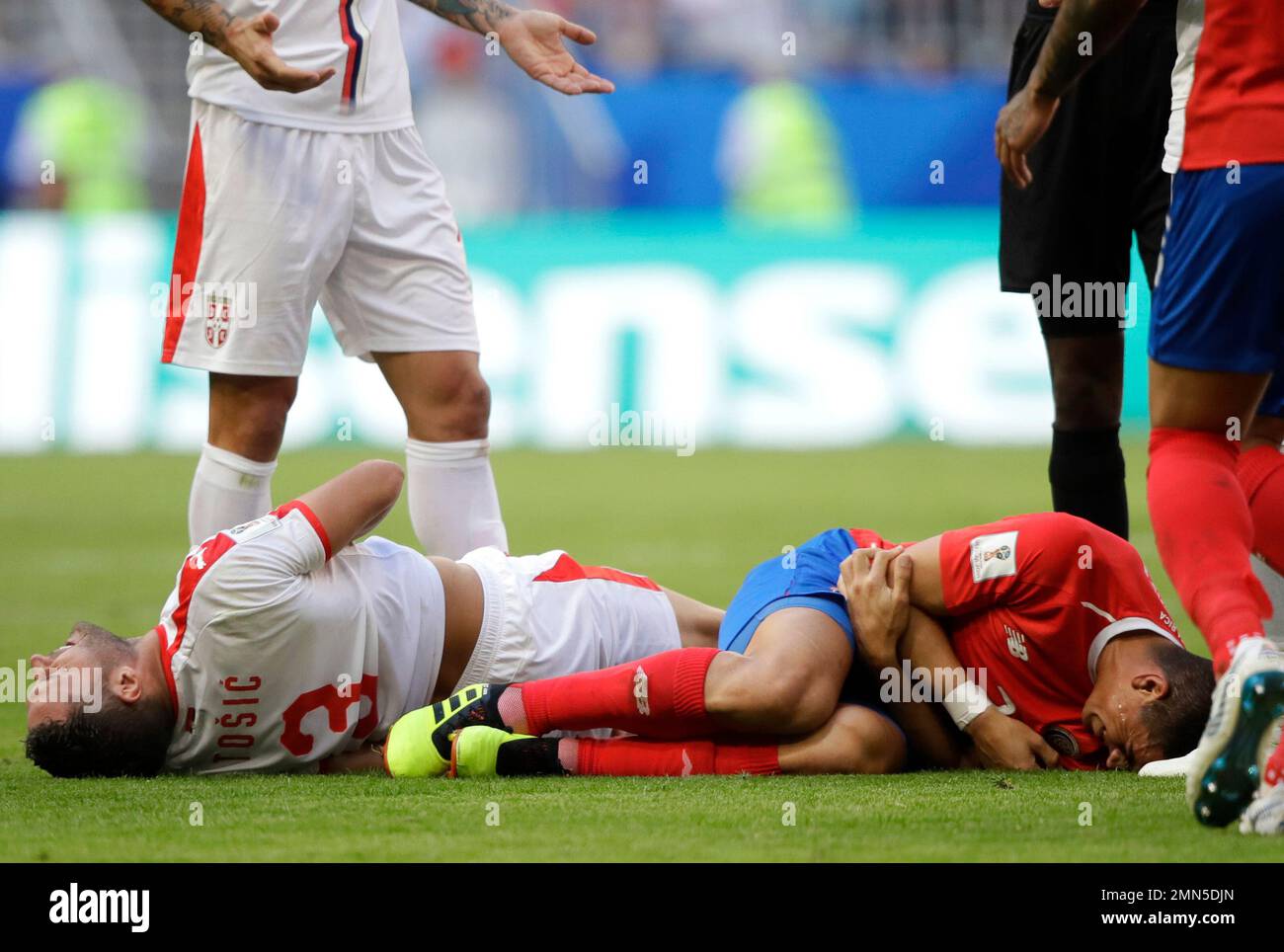 Serbia's Dusko Tosic and Costa Rica's Johnny Acosta react at the ground ...