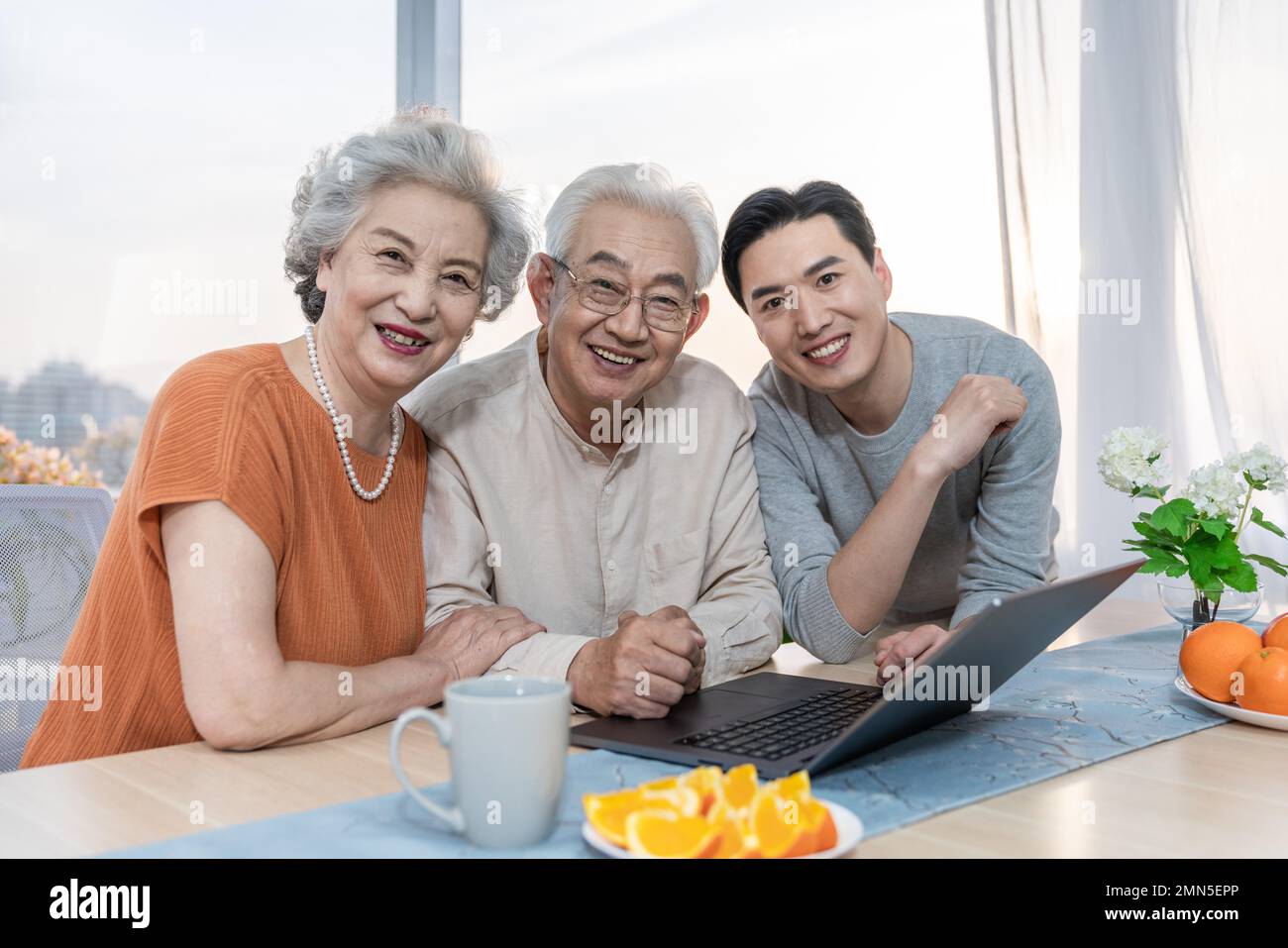 Happy family using laptops Stock Photo - Alamy