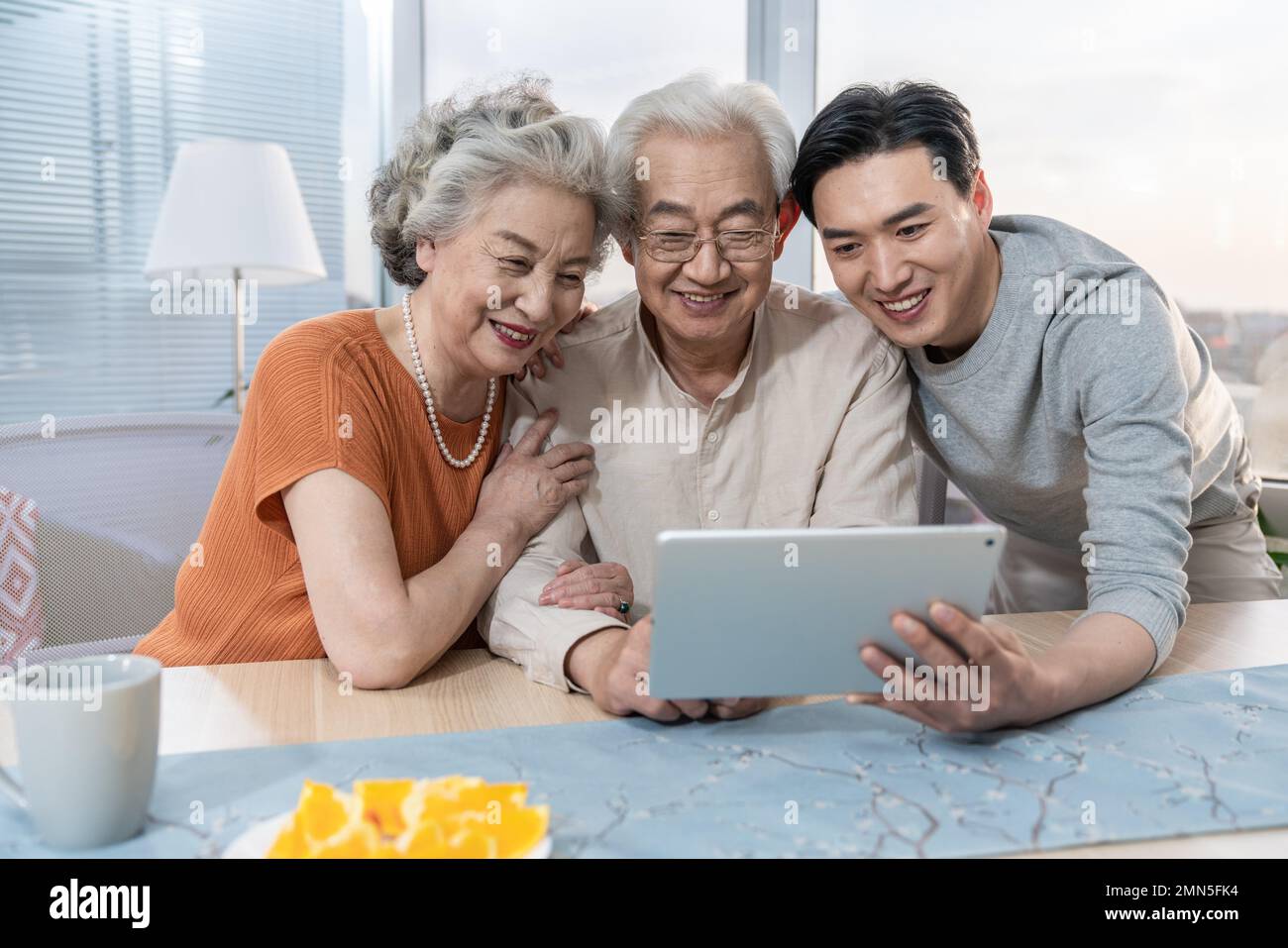 Happy family use tablet computers Stock Photo - Alamy