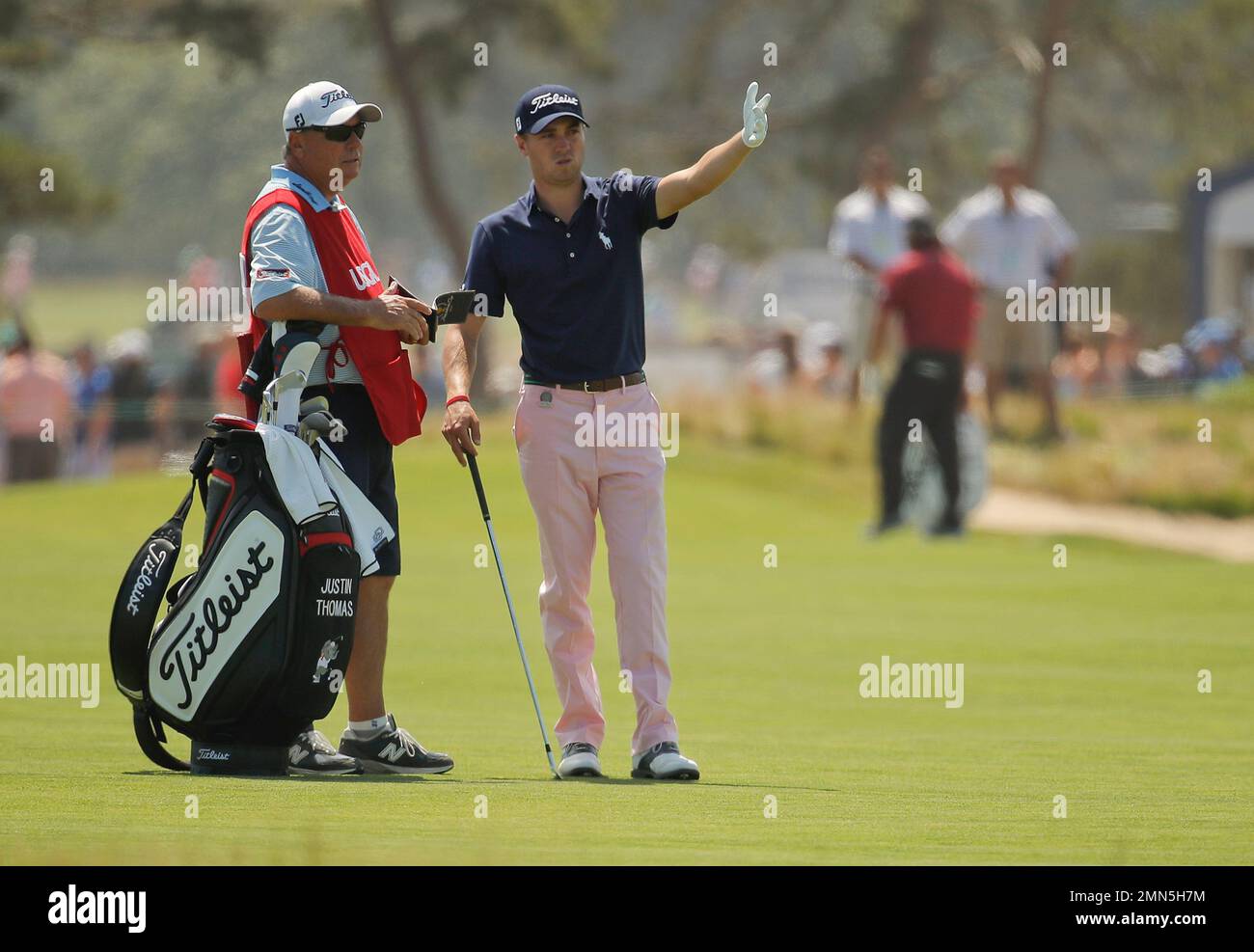Justin Thomas talks to his caddie on the fifth hole during the third ...