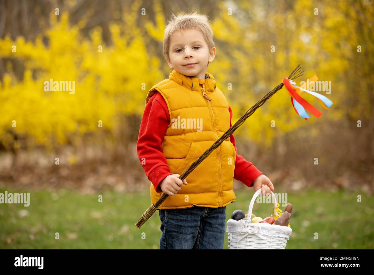 Cute preschool child, boy, holding handmade braided whip made from ...