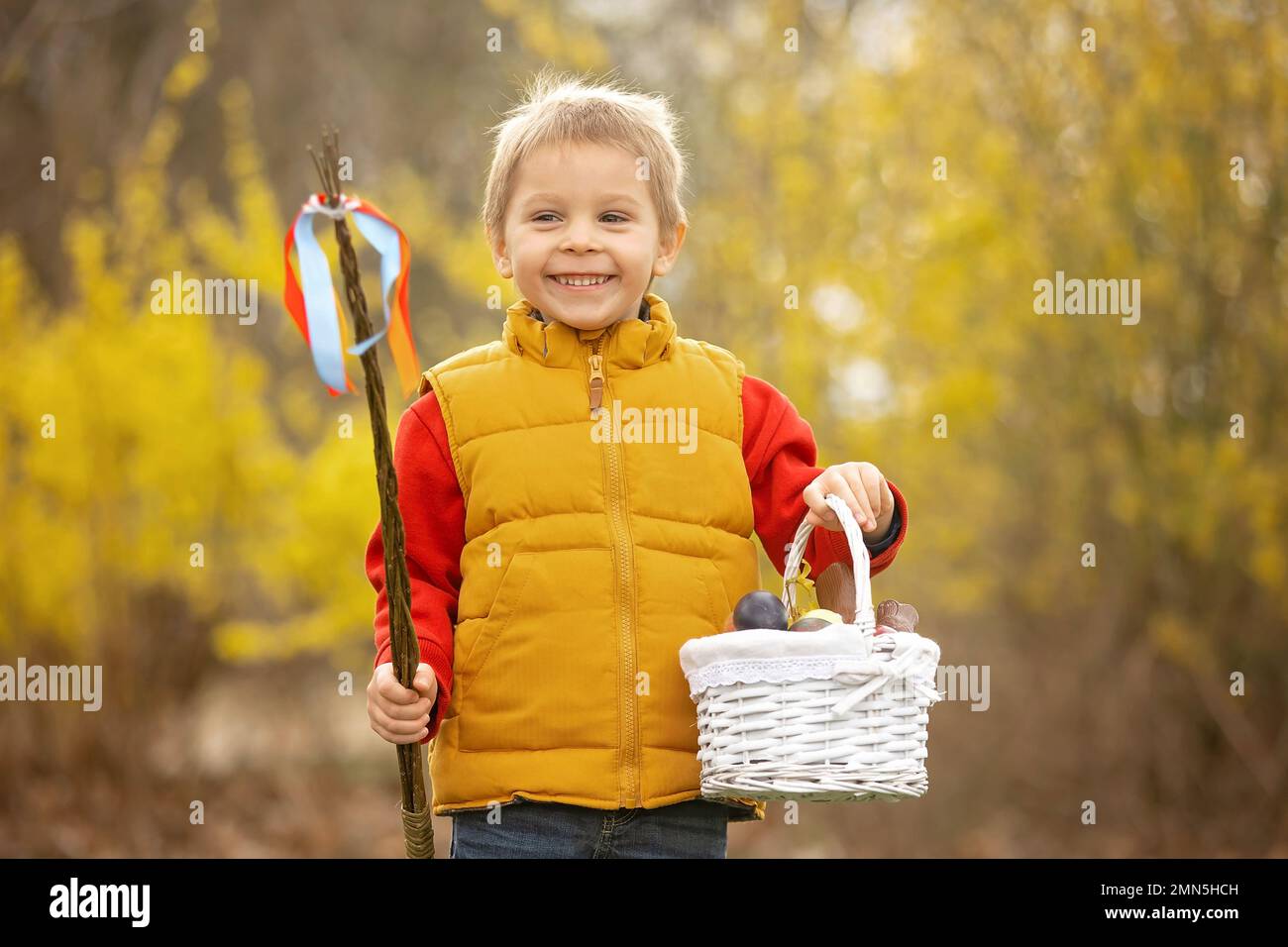 Cute preschool child, boy, holding handmade braided whip made from ...