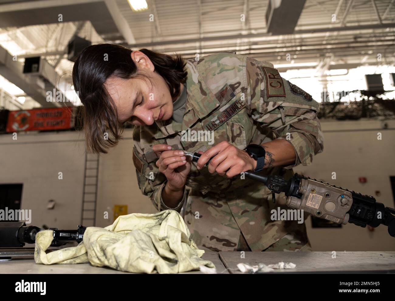 Tech. Sgt. Victoria Turan, 621st Contingency Response Squadron programs manager, cleans her M4 ...