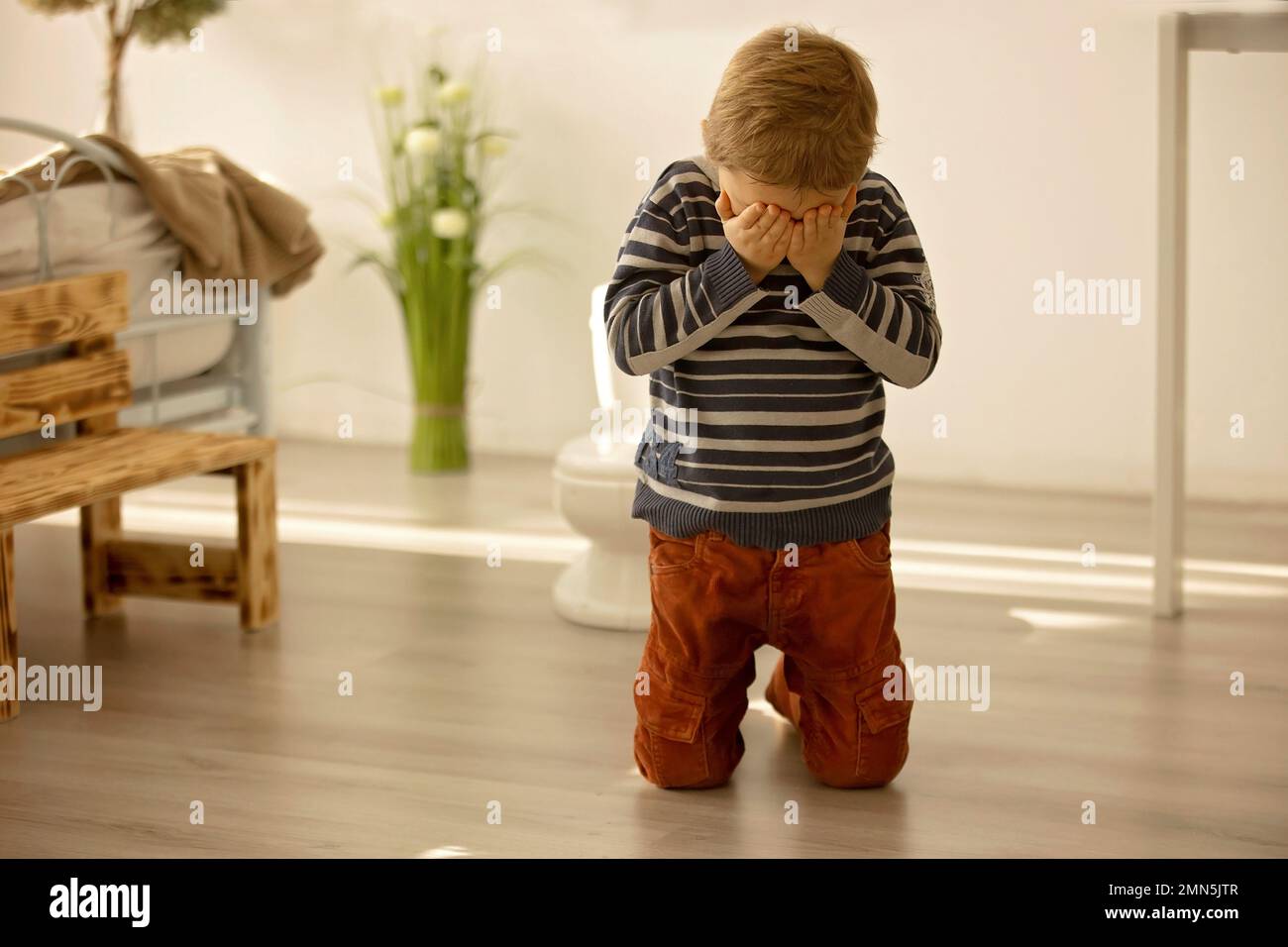 Little toddler child, boy, pee in his pants while playing with toys ...