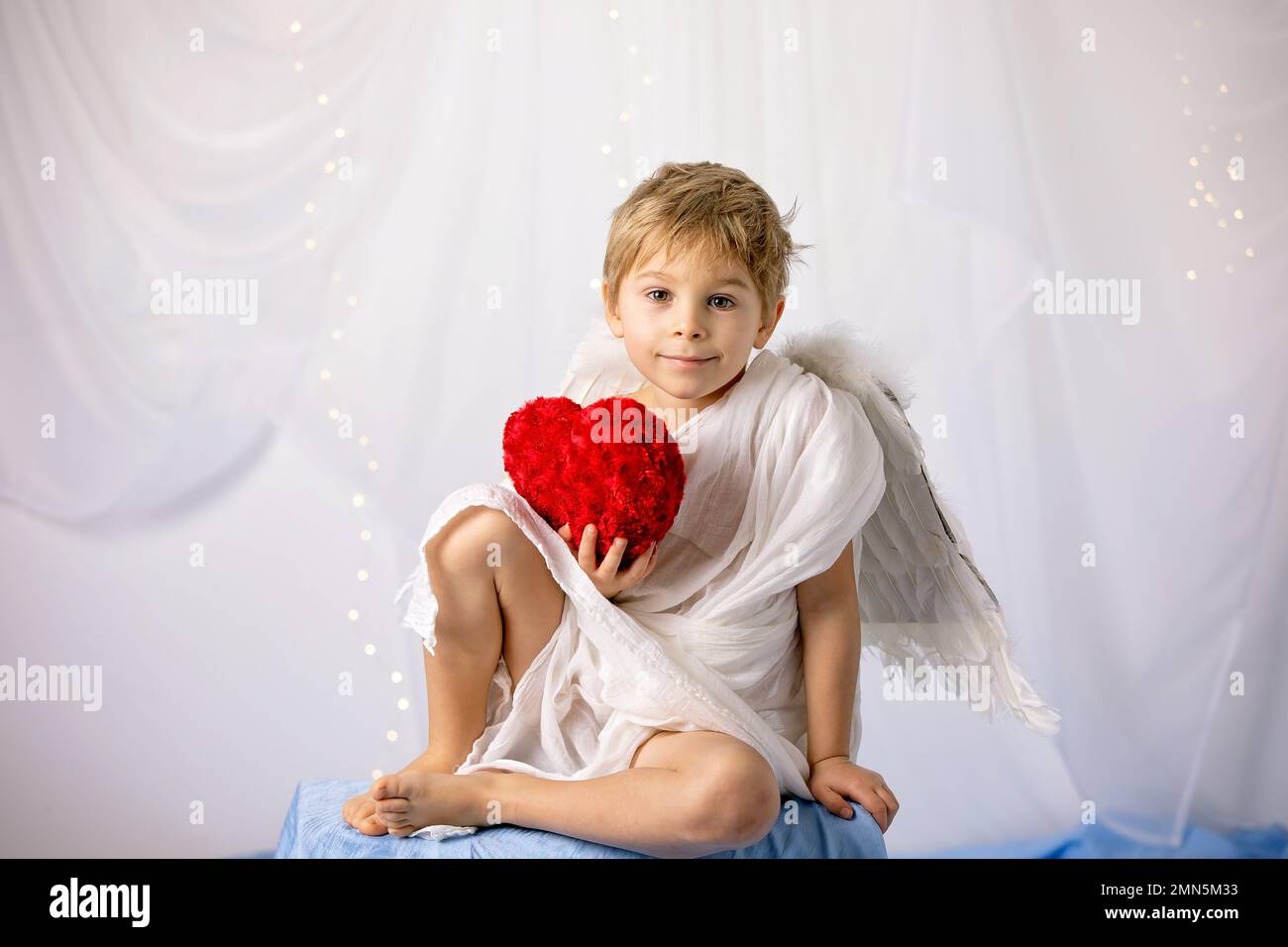 Little cupid toddle boy, holding bow and arrow, beautiful blond cherub ...