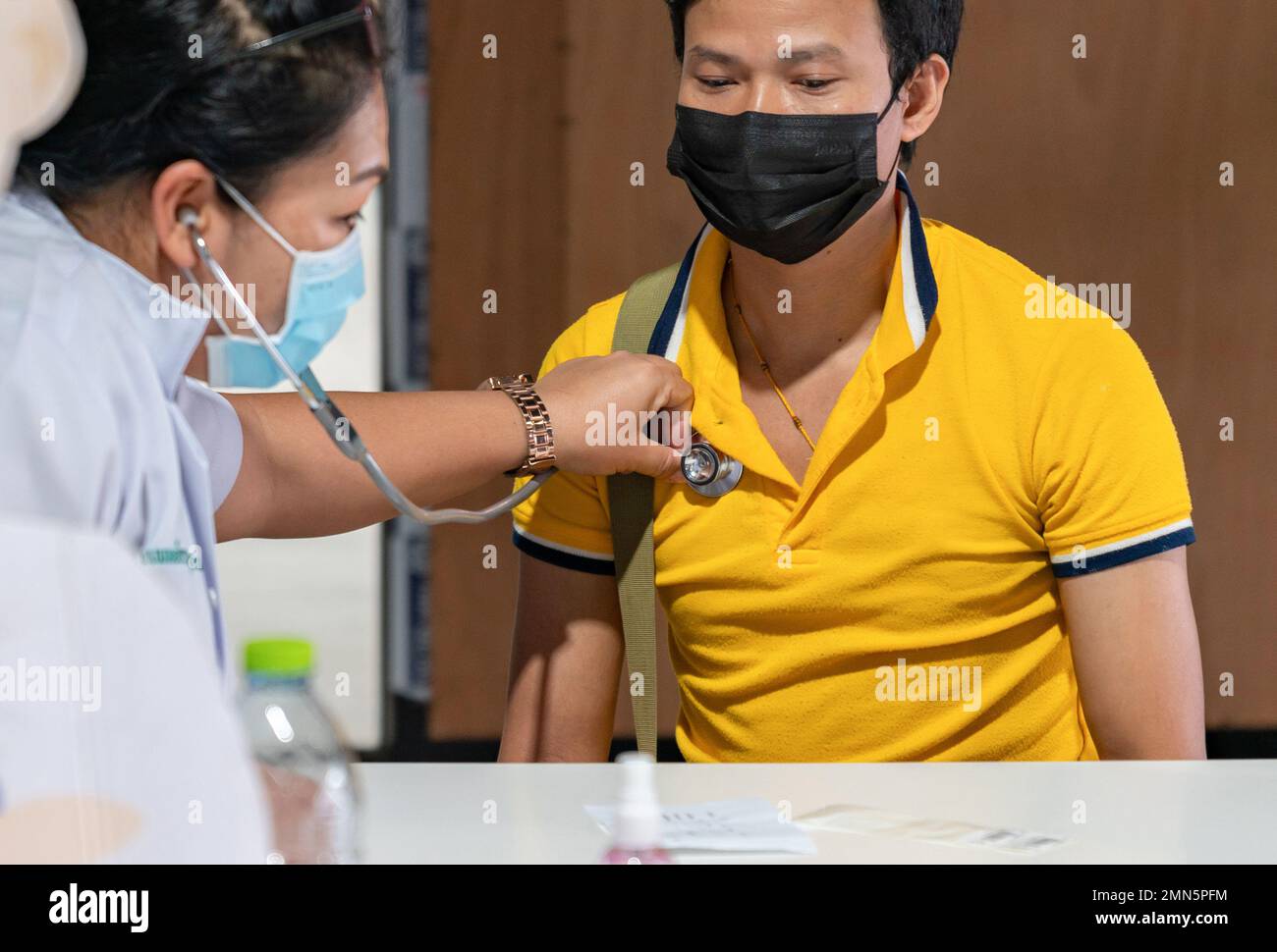 The doctor uses a stethoscope to examine the patient's heart pulse ...